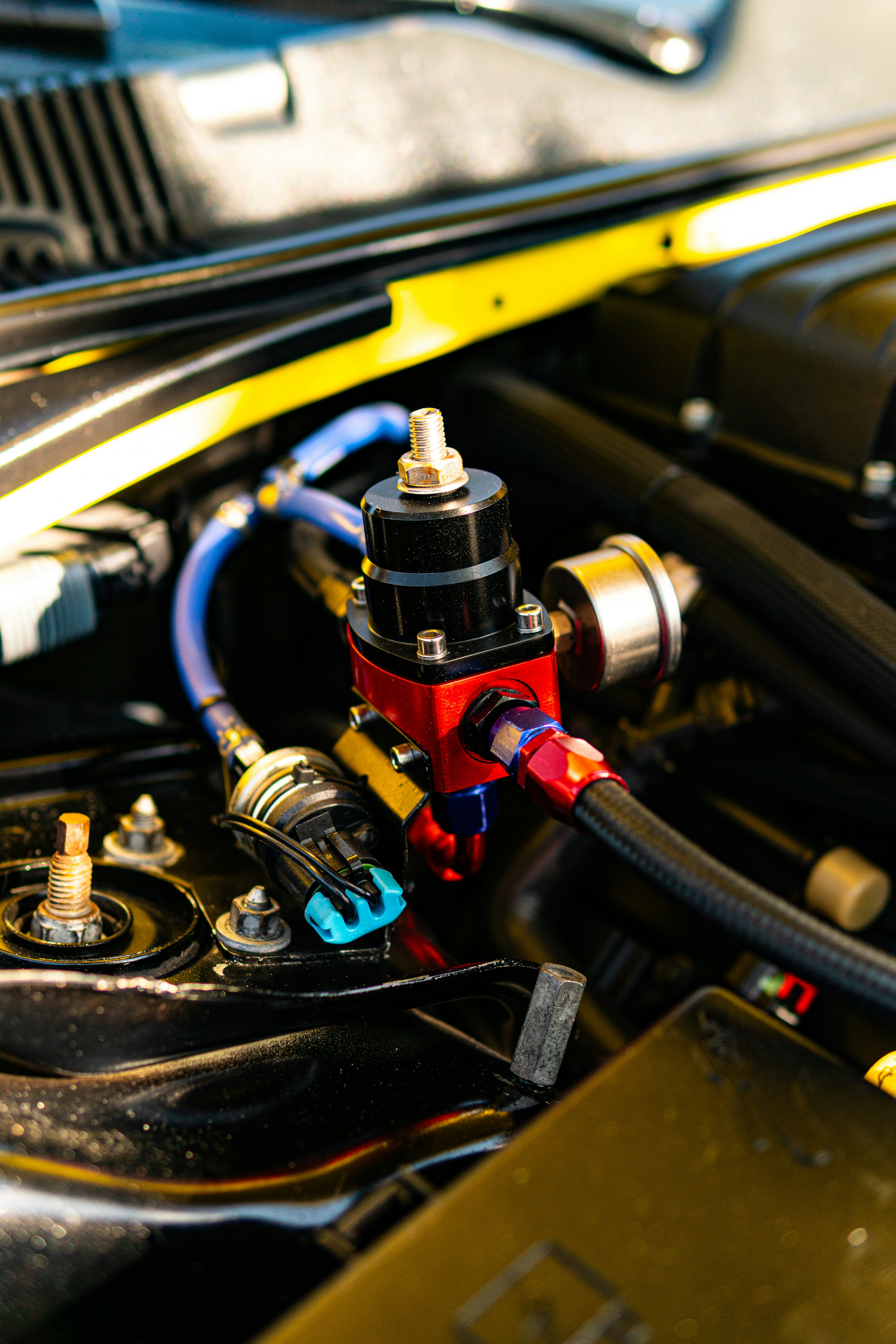 Turbocharged Grounding: A Close-Up on the Red anodized Fittings in a Car Engine