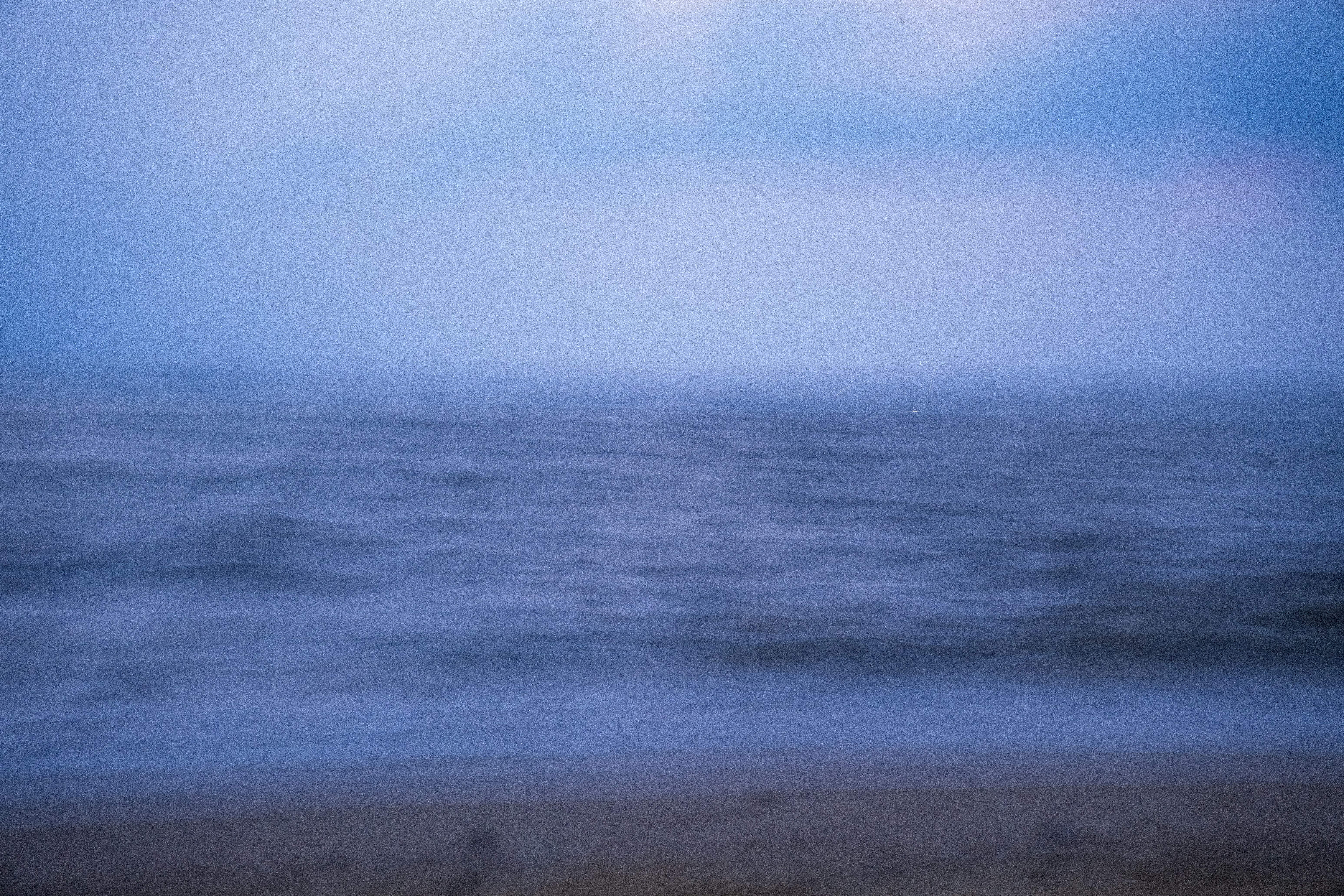 Mist over the Pacific: a blurred shoreline at blue hour