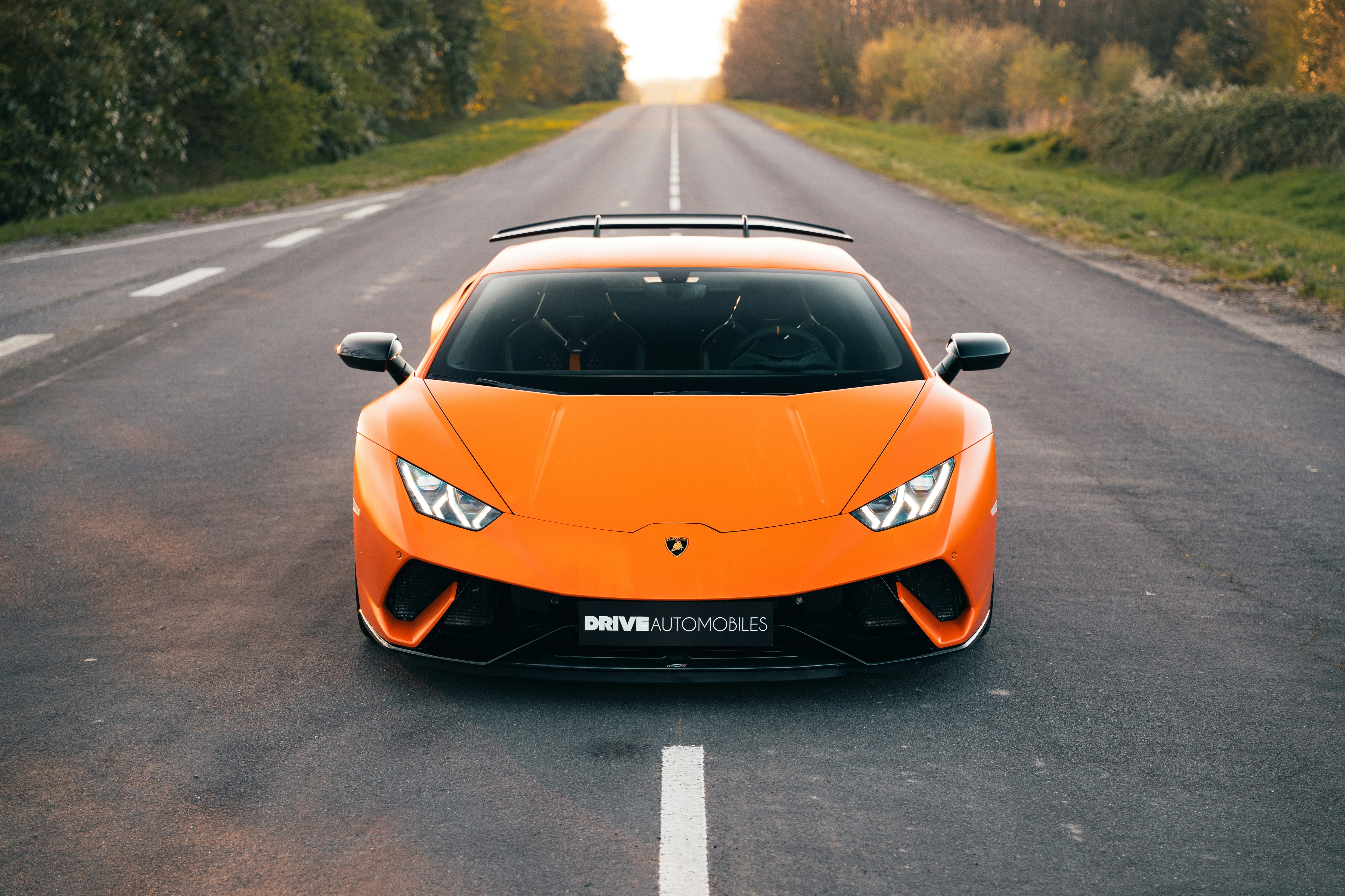 Orange Lambo on an Open Road
