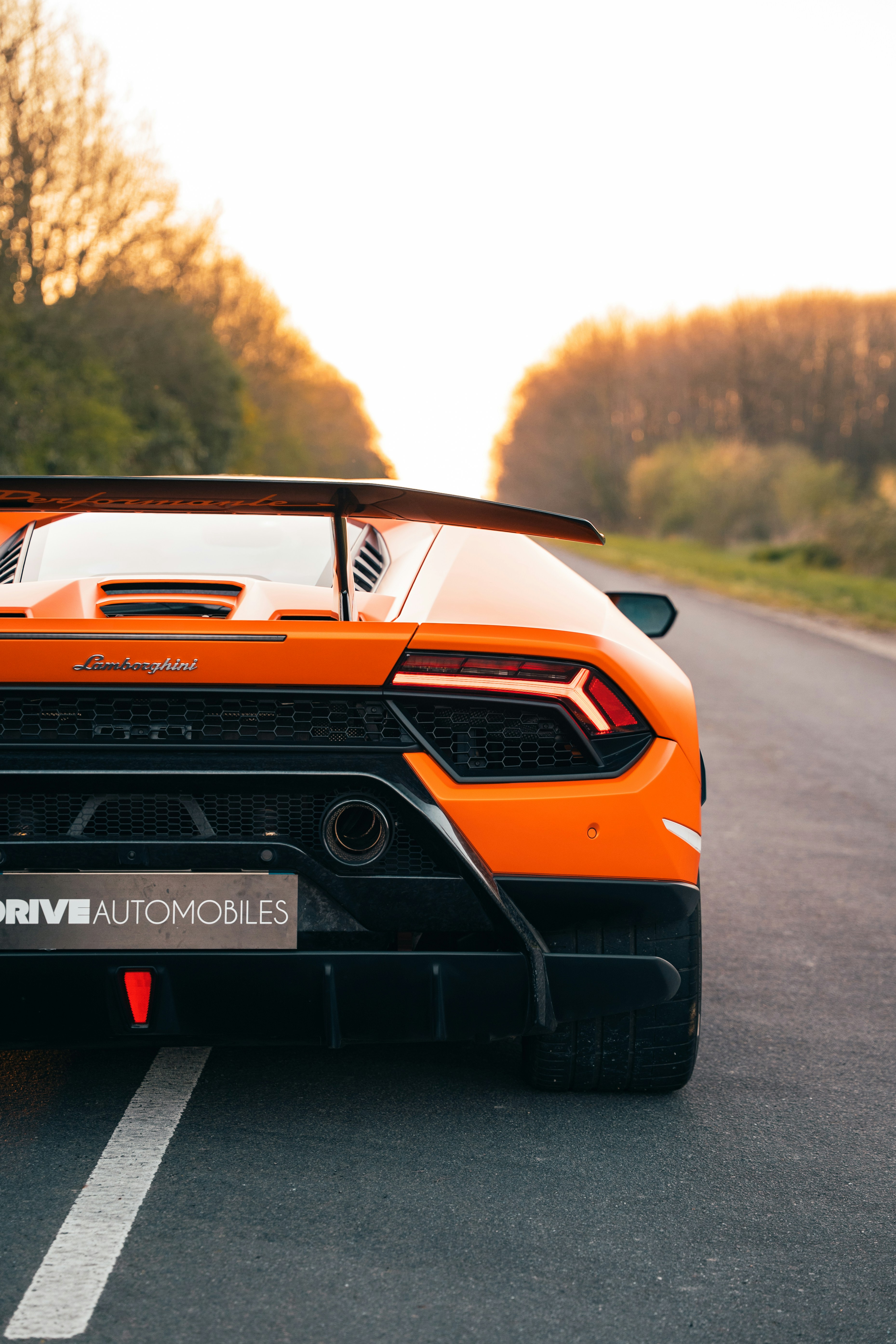 Orange Lambo at the Road’s Edge: A Bold Tailpiece of Speed