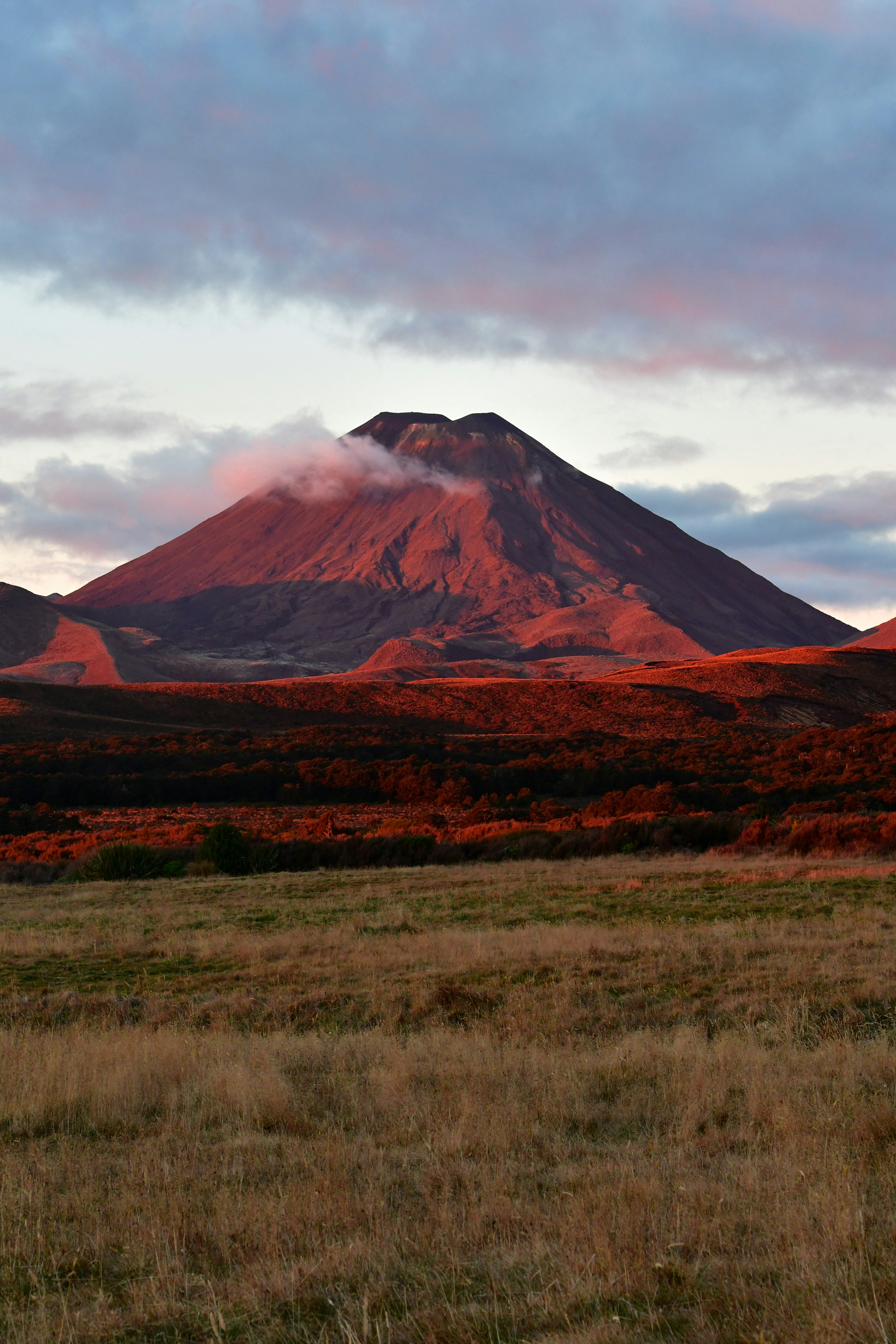 Crimson Cone at Dusk: A Volcanic Sentinel over Open Plains