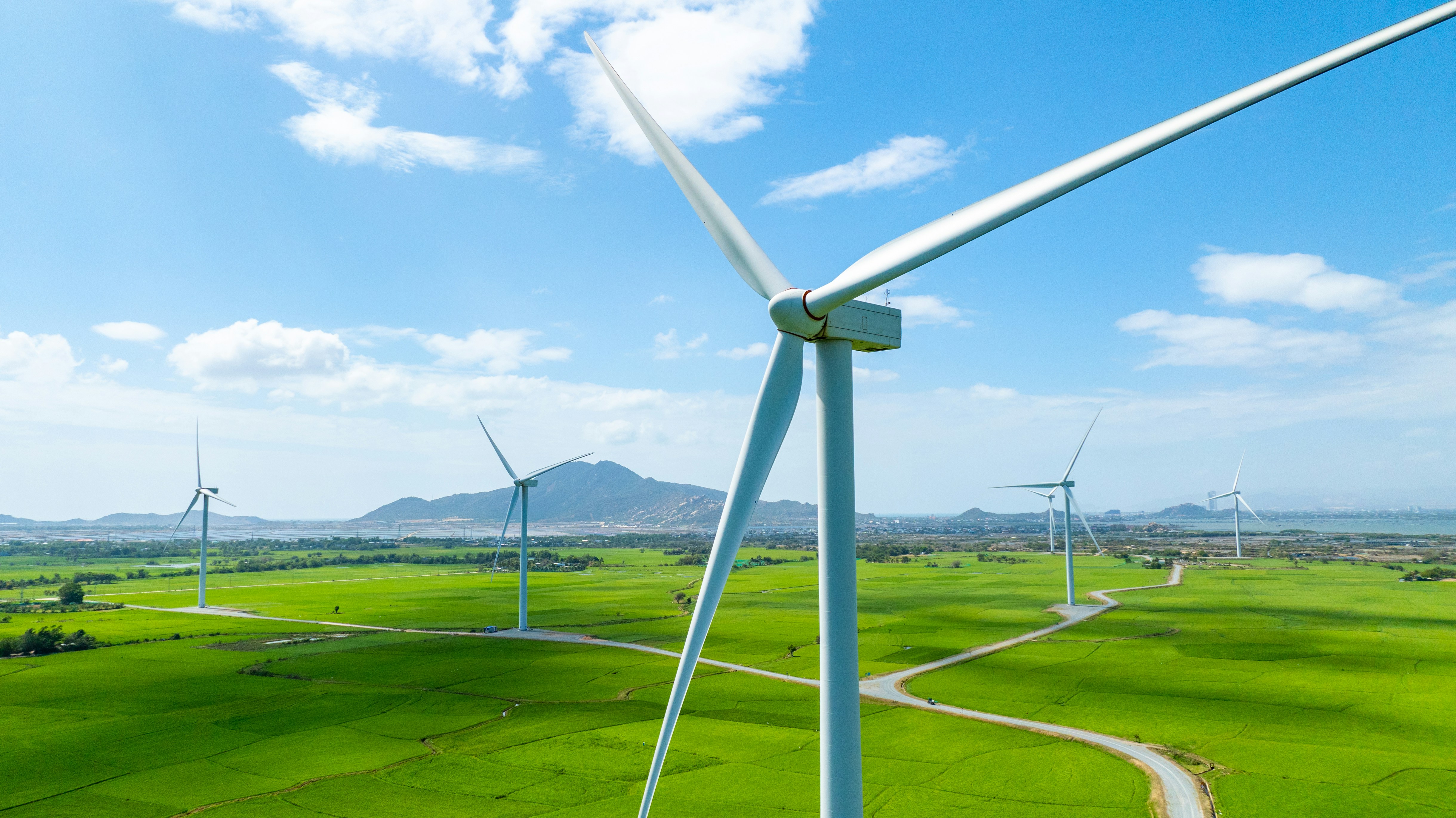 Wind turbines in a vast green field with blue sky. photo – Free Blue ...