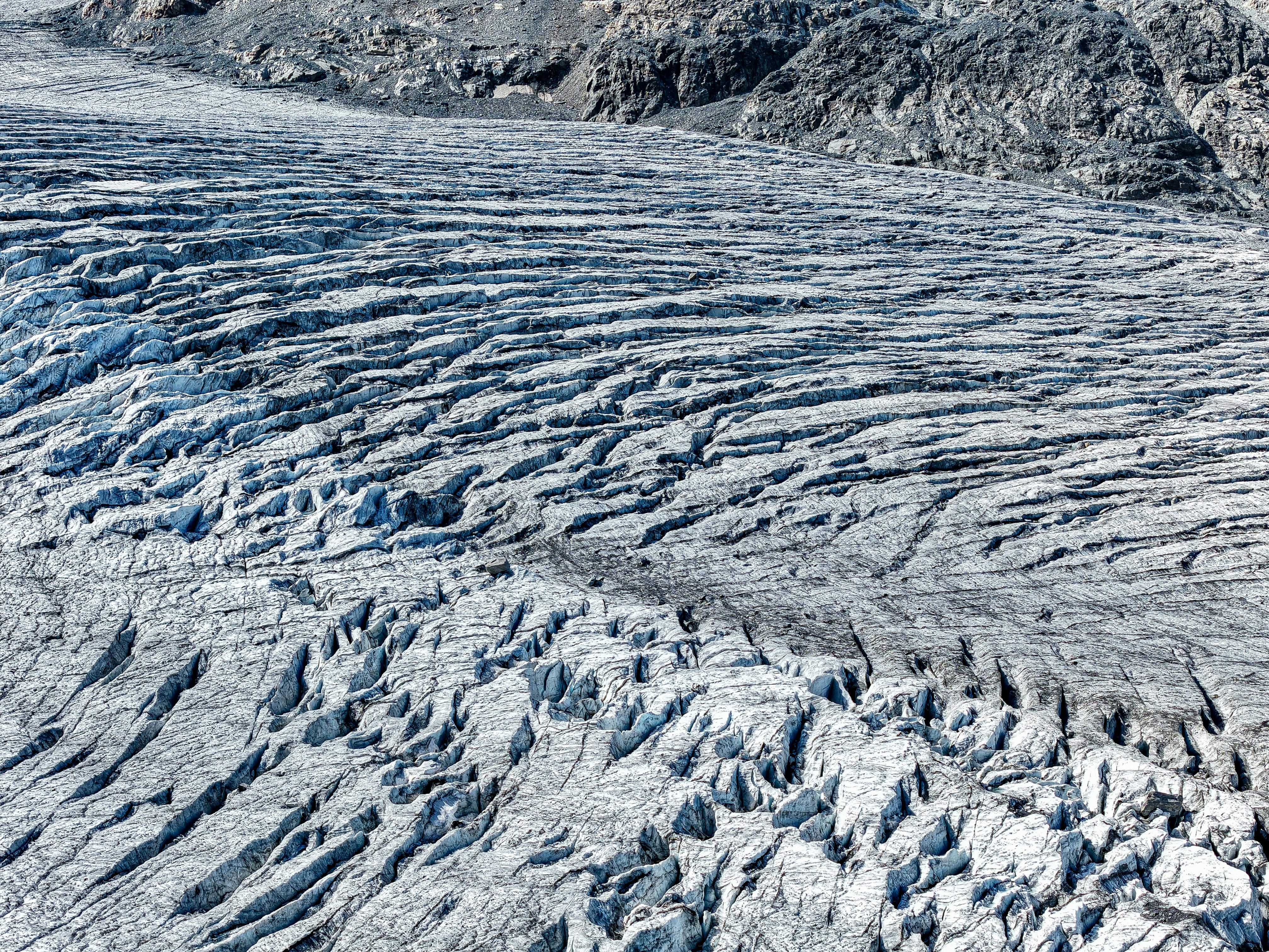 Ridges of Ice and Stone: A Glacial Sweep Across Striated Fjord