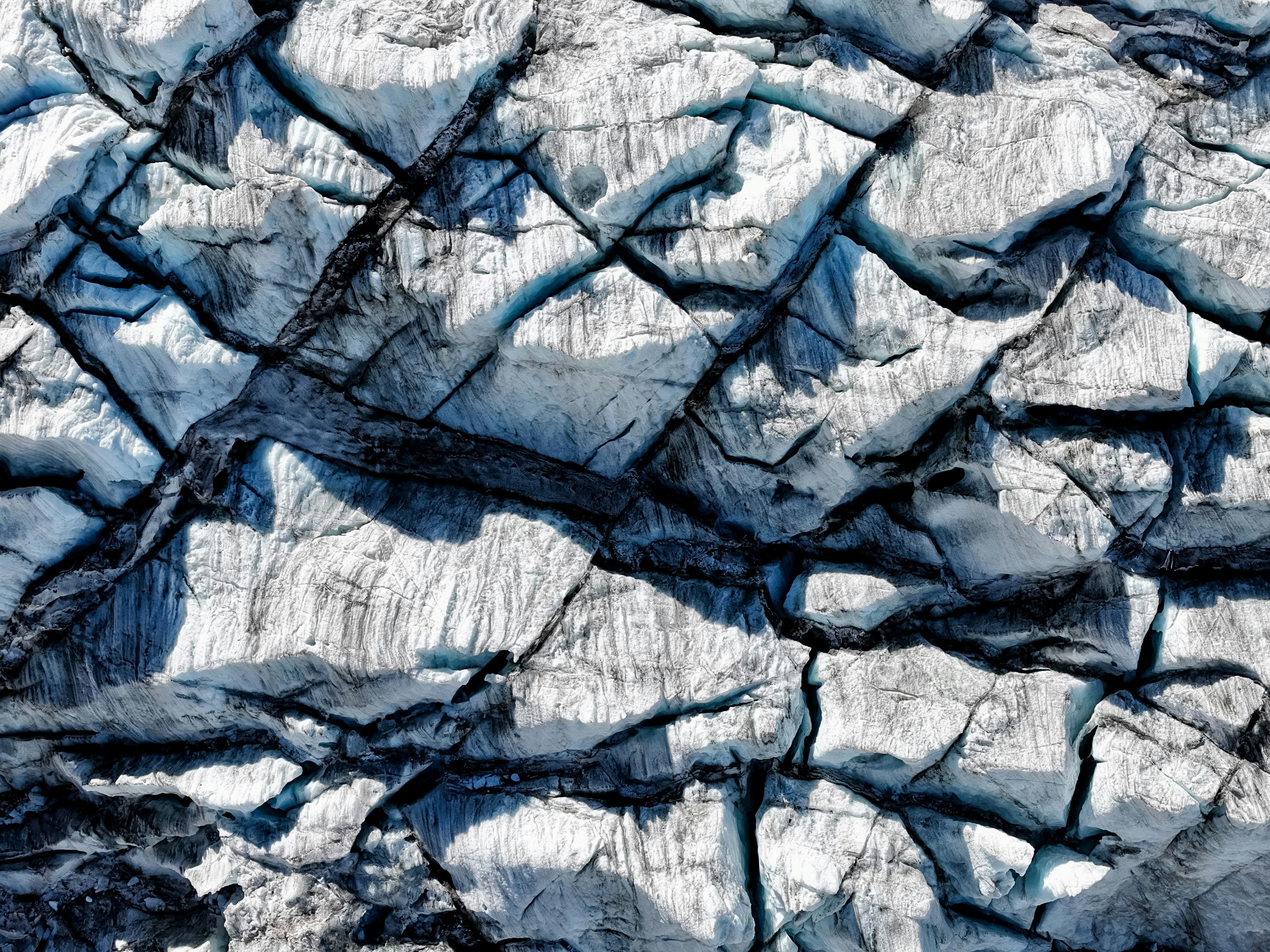 Fractured ice: a mosaic of blue shadows and sunlit crevasses
