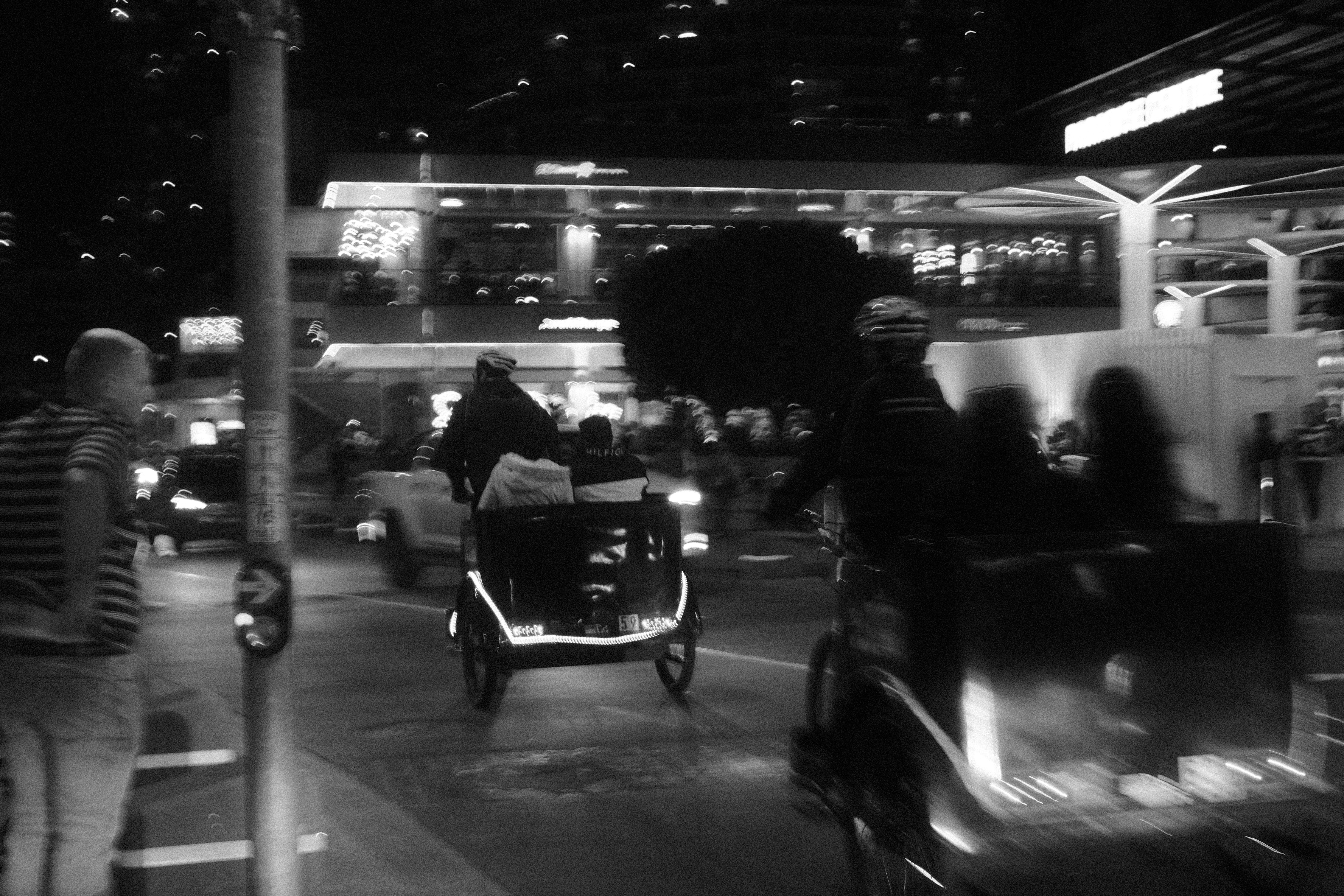 Midnight Ride: A Quiet Carriage Amid Busy Night Market Scenes
