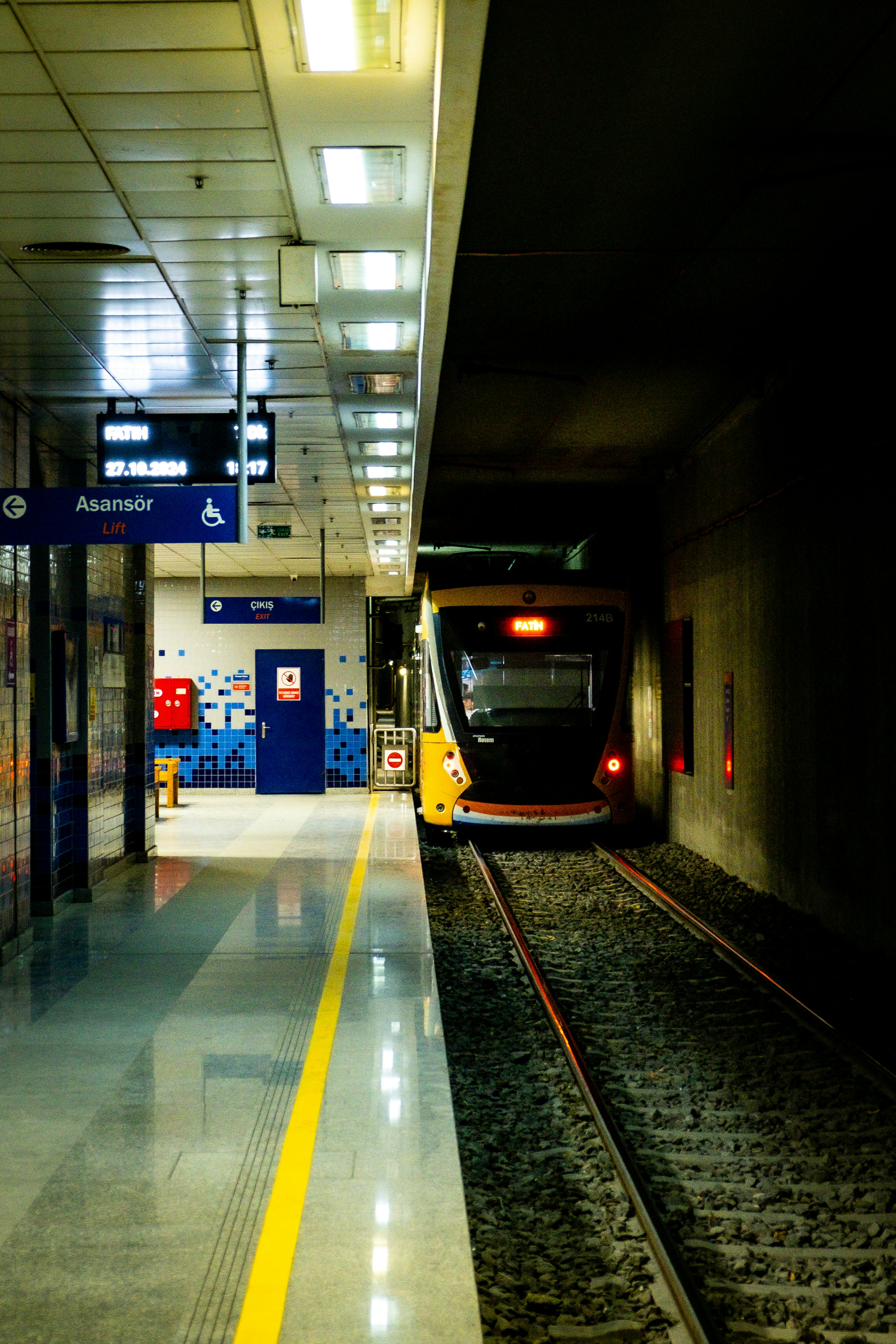 Midnight Commute: A Train Emerges from the Tunnel into Harsh Fluorescent Light