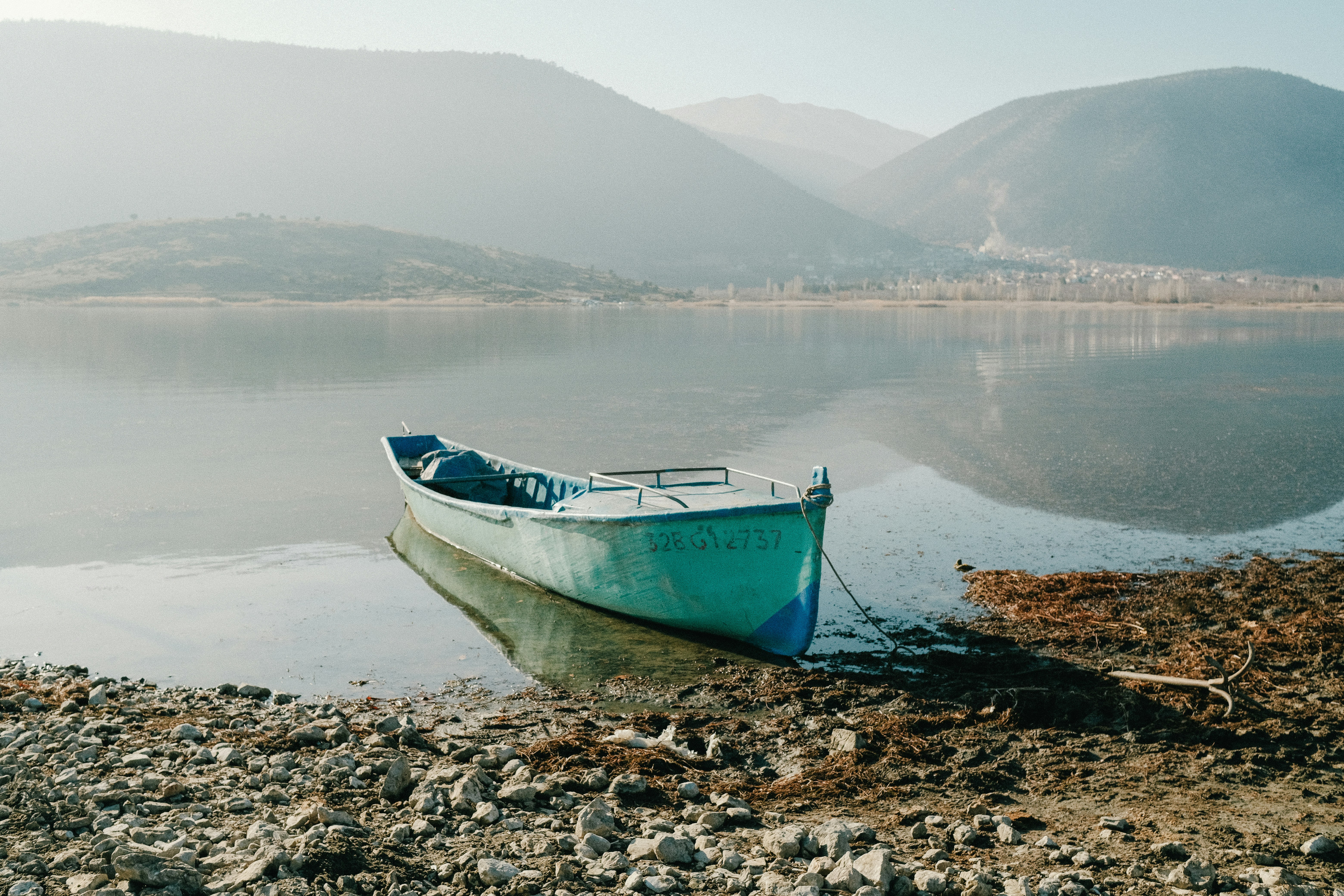 Blue Boat at the Quiet Edge of the Lake