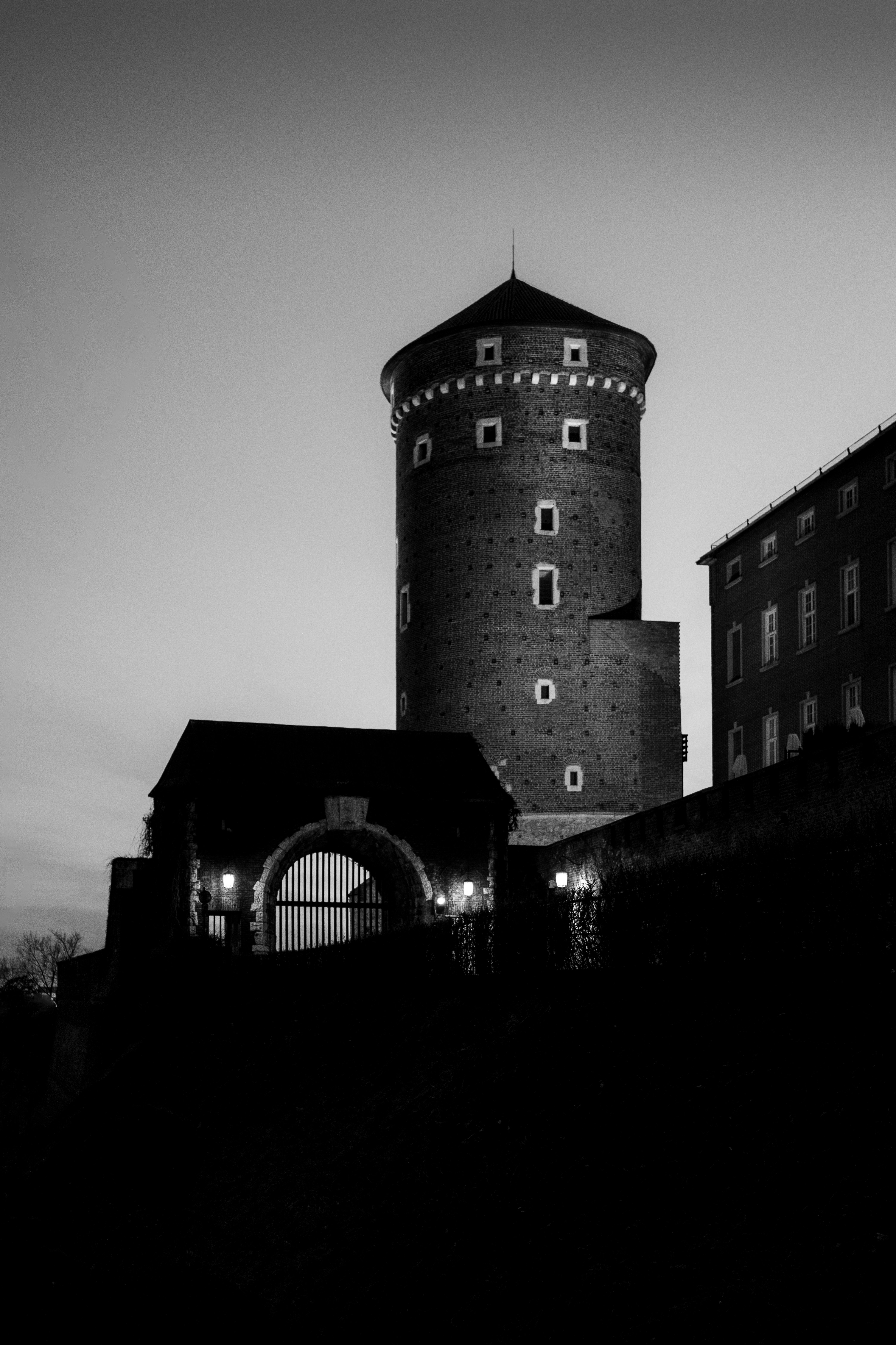 Guarded Turret at Dusk: A Monochrome Pier in the Shadow of the Gate