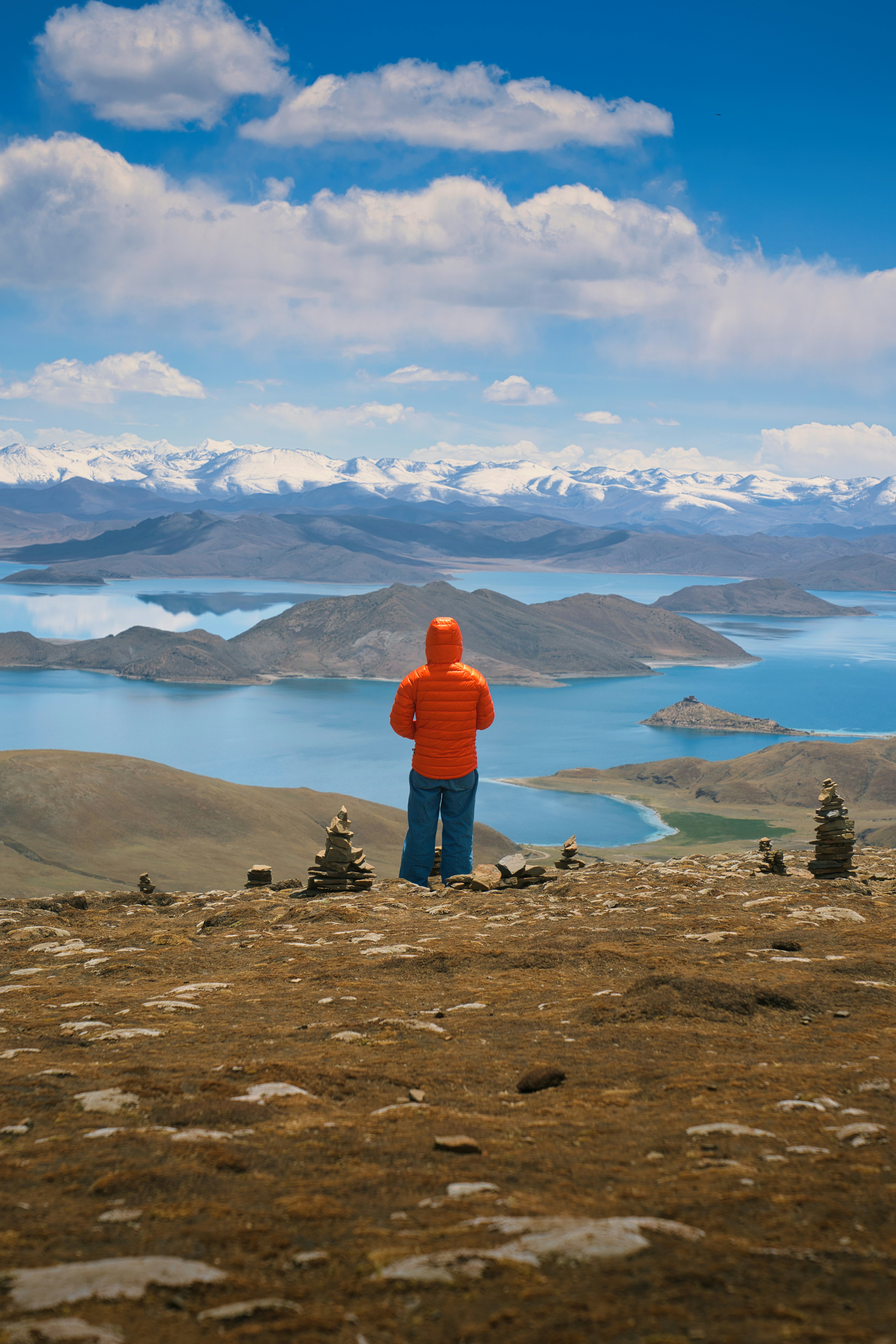 Orange Jacket Overlooking Alpine Lakes from a High Crest