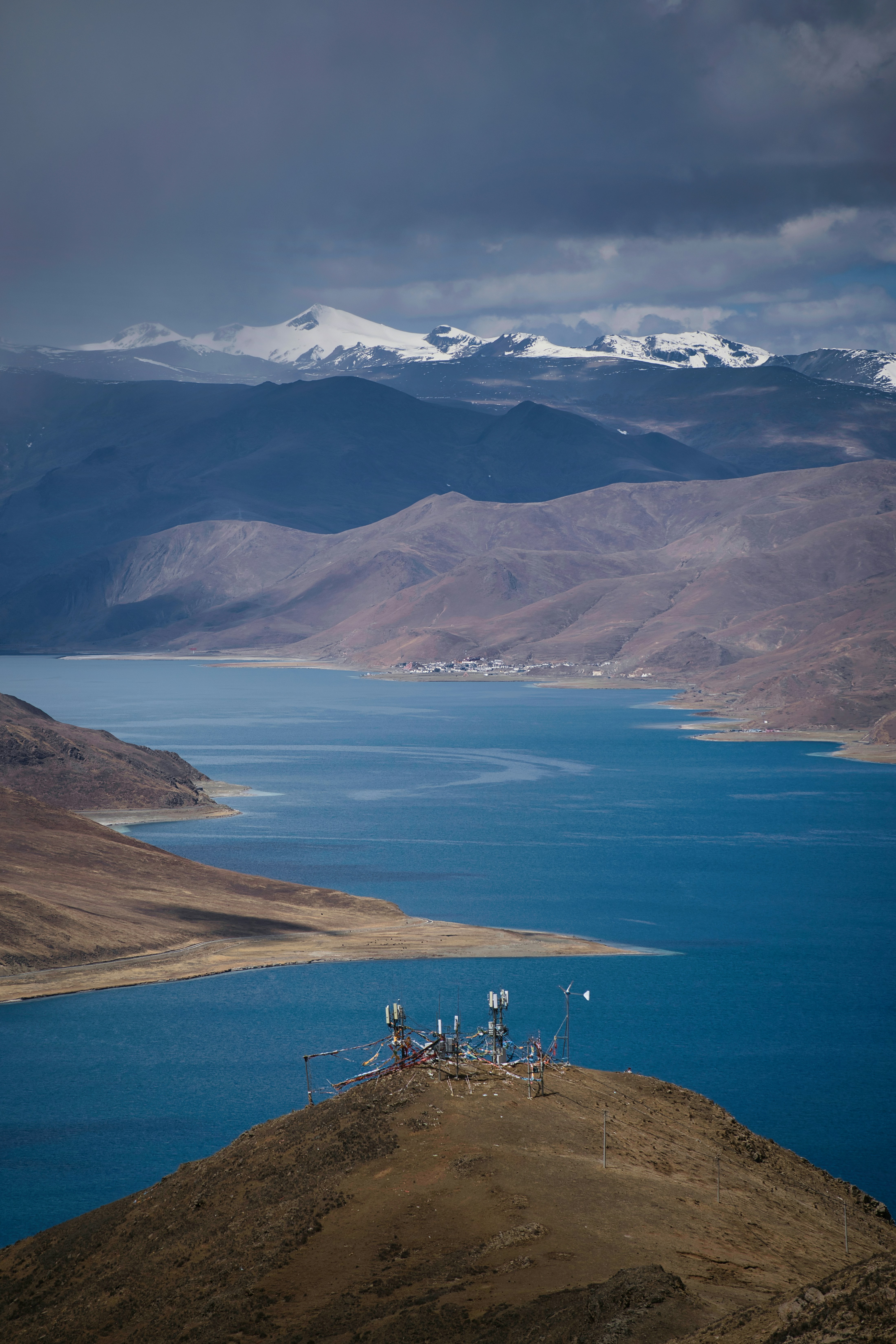 Ridge and Reservoir: Snow-Capped Peaks Beyond a Serene Fjord