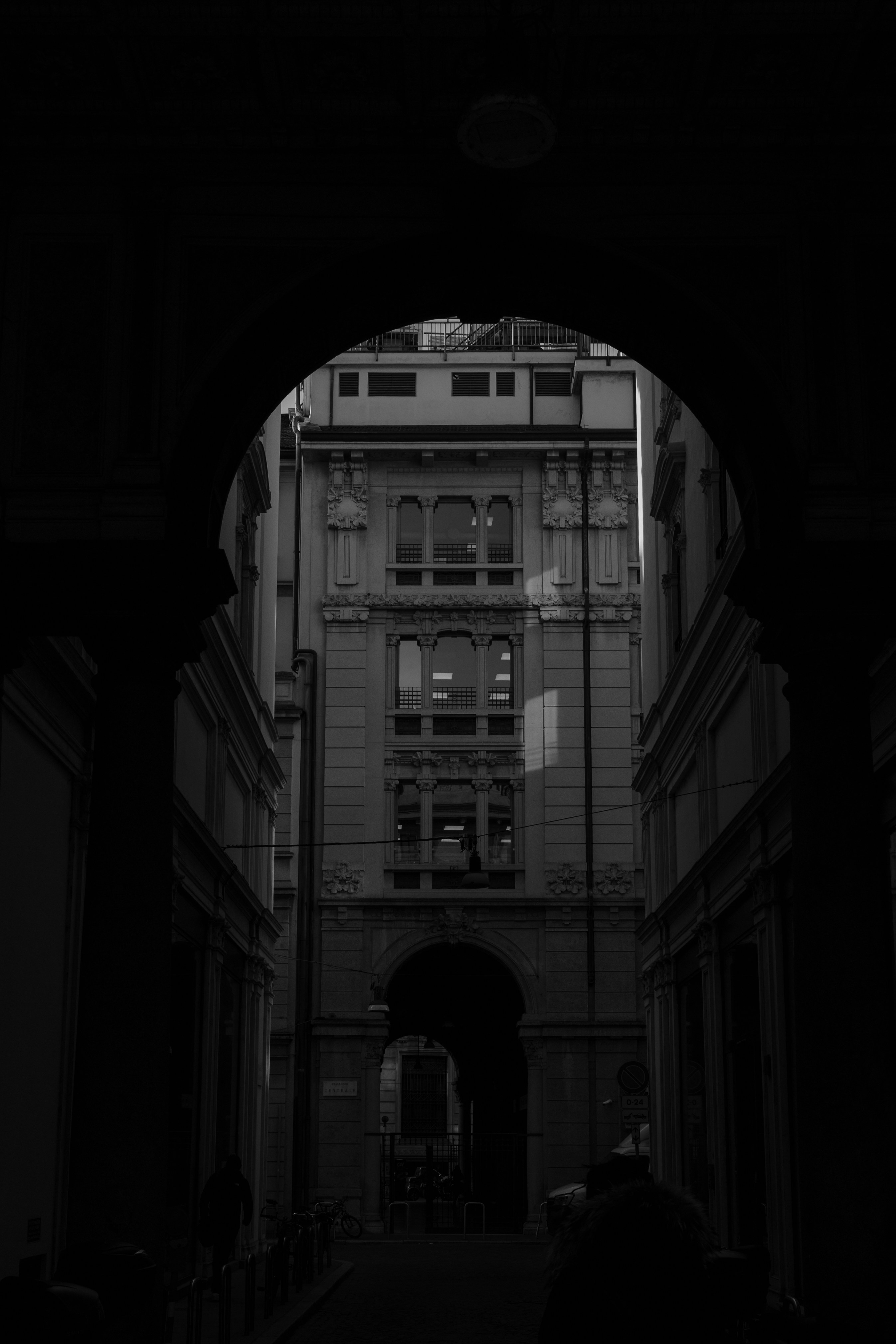 Archway to the City: Light Filtering Through a Darkened Courtyard