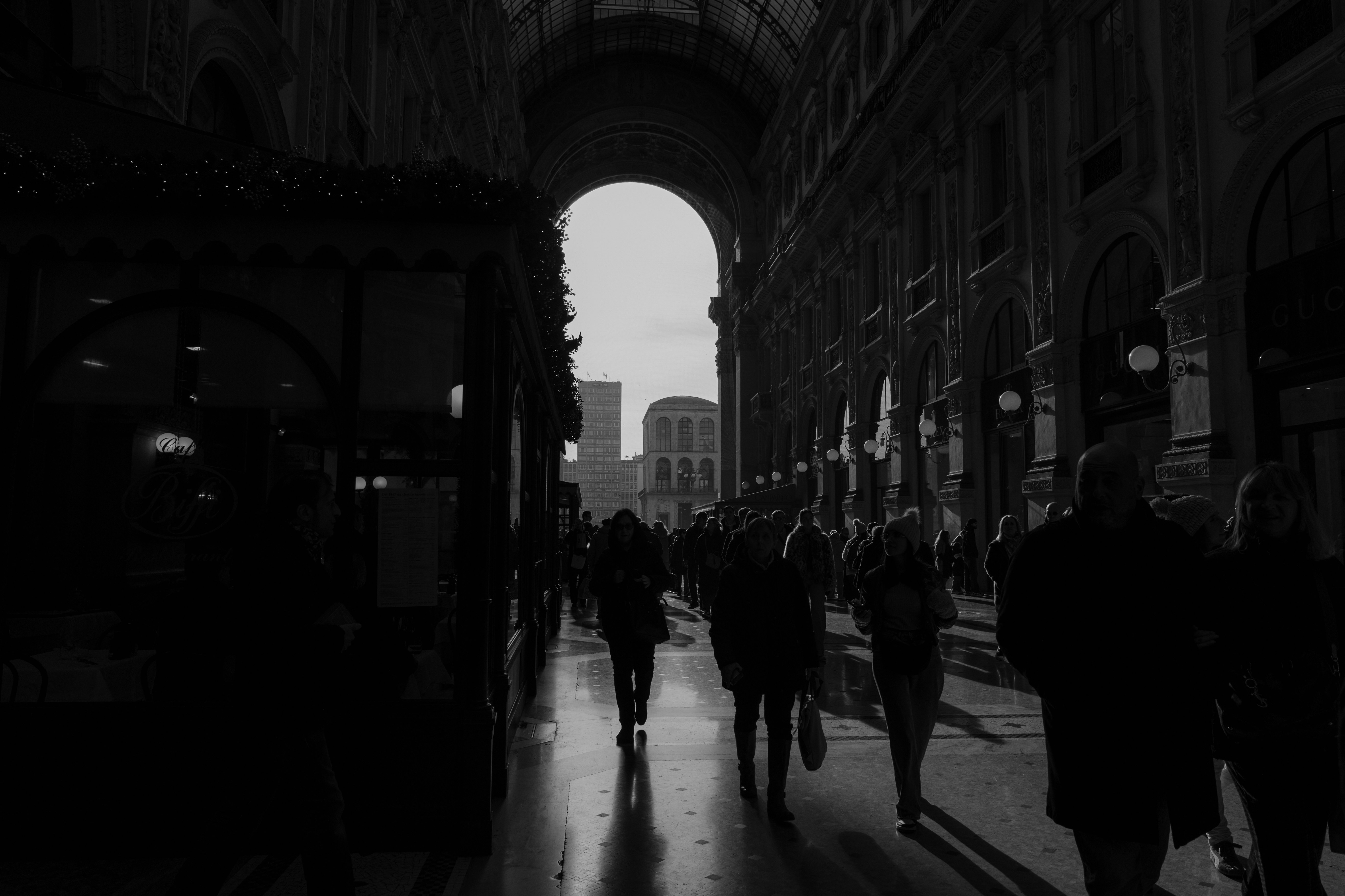 Arched Passageway at Dusk: People in a Quiet Cathedral of Market