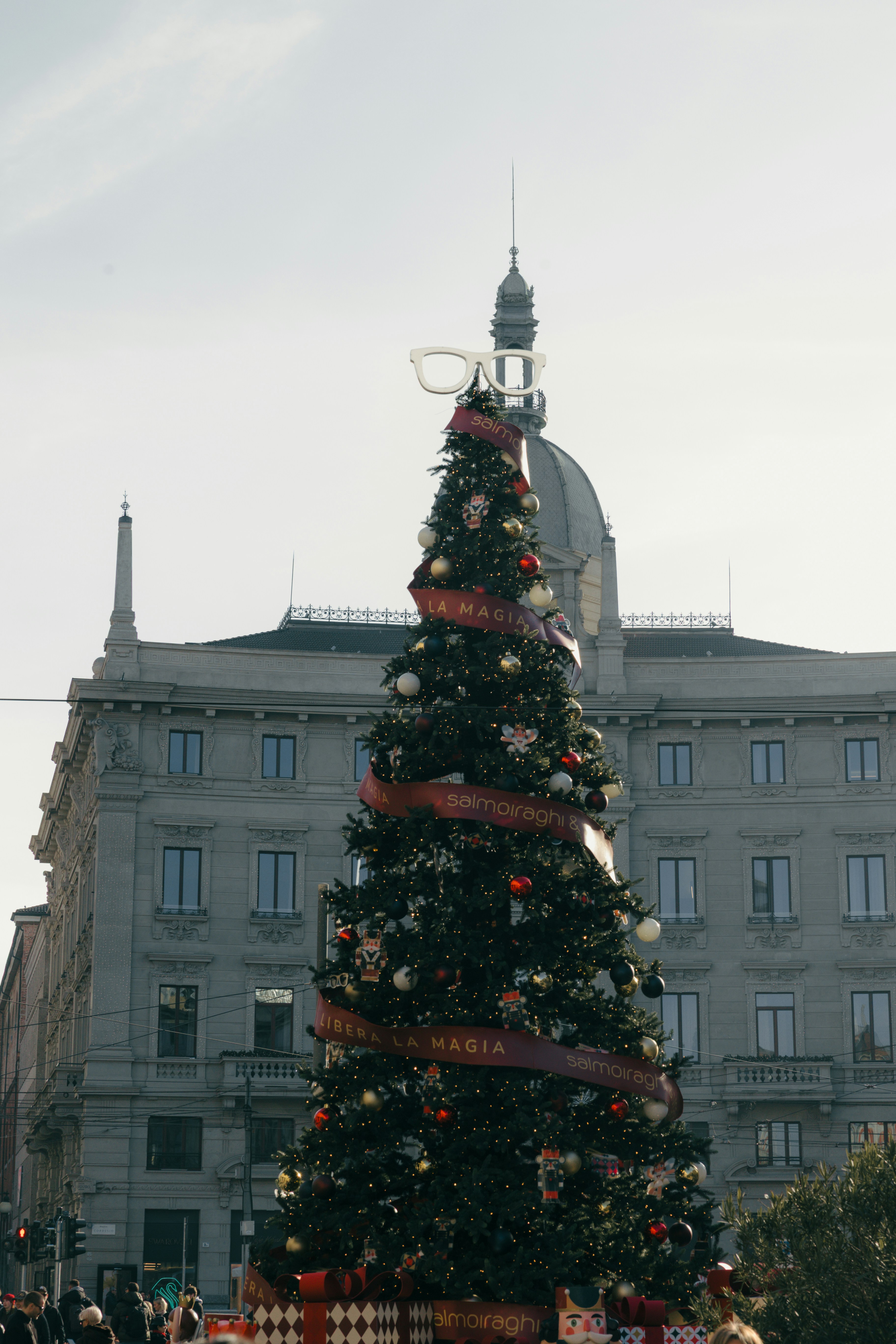 Glowing Yuletide: A City Christmas Tree Crowned with Quirky Glasses