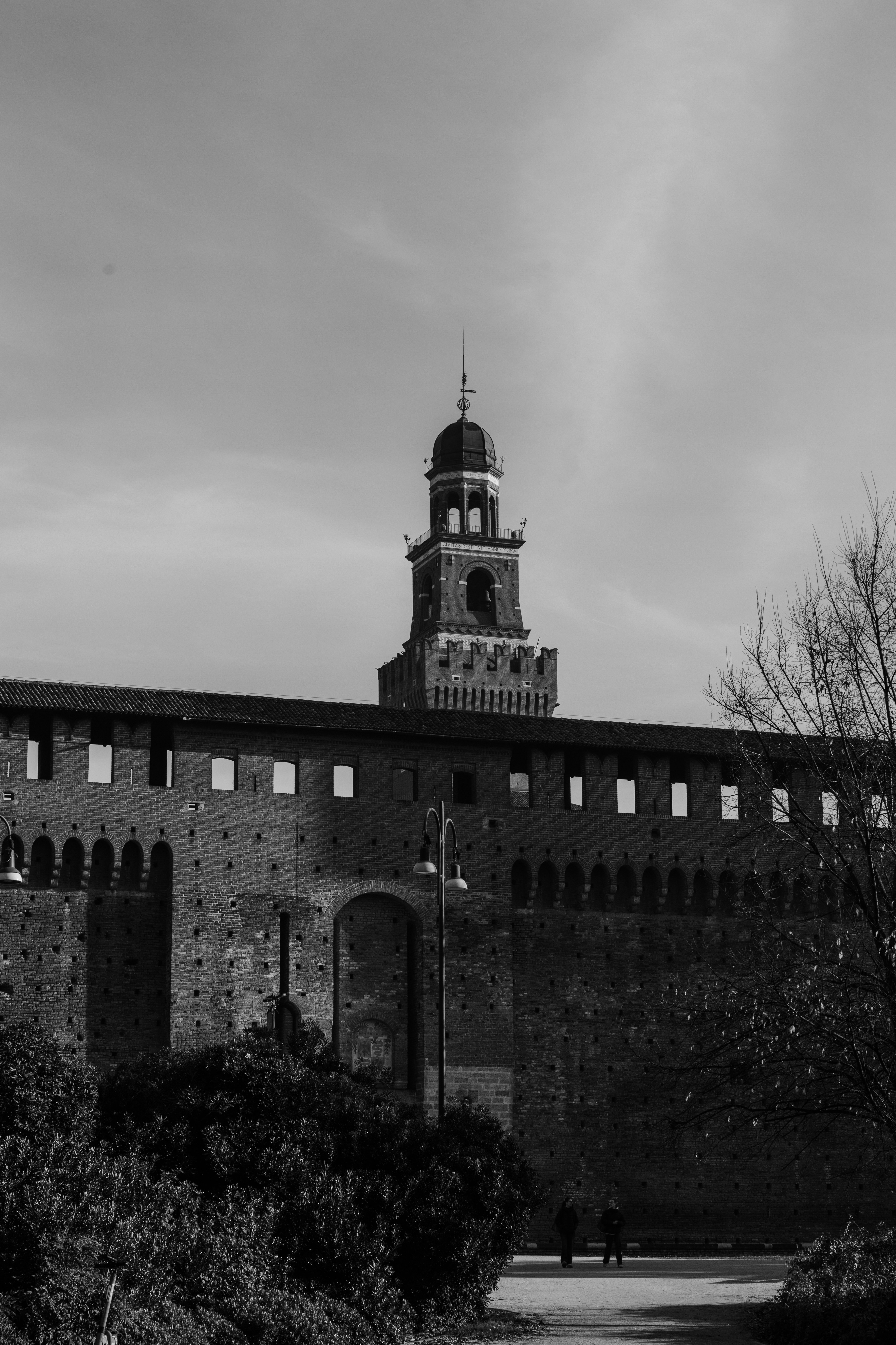Fortress Skyline: A Towering Clocktower Above the Brick Ramparts