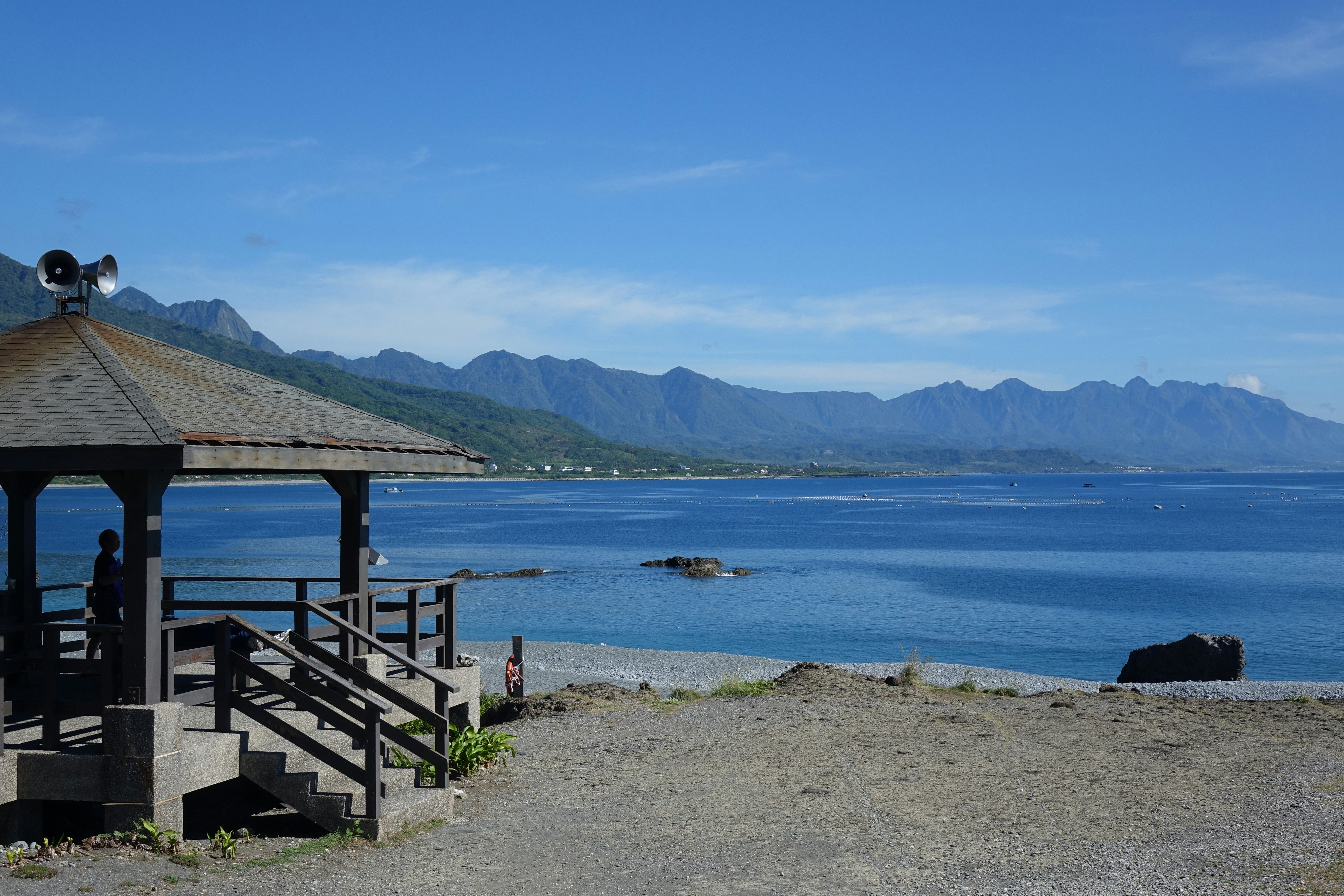 Shoreline Watch: A Quiet Coastal Rendezvous Beneath a Seaside Pavilion