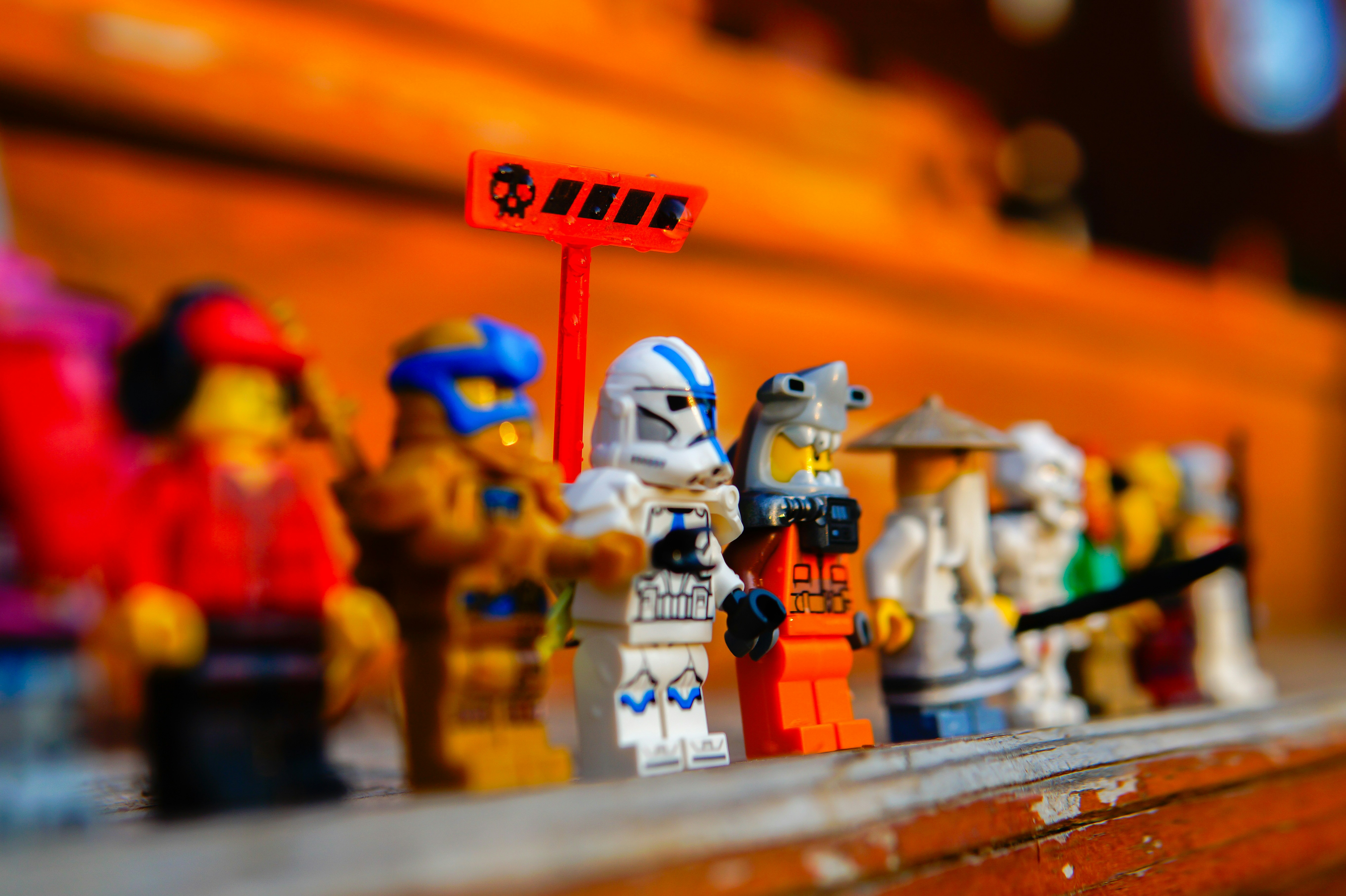 Chessboard of Lego Warriors: A Row of Colorful Minifigs on a Wooden Shelf
