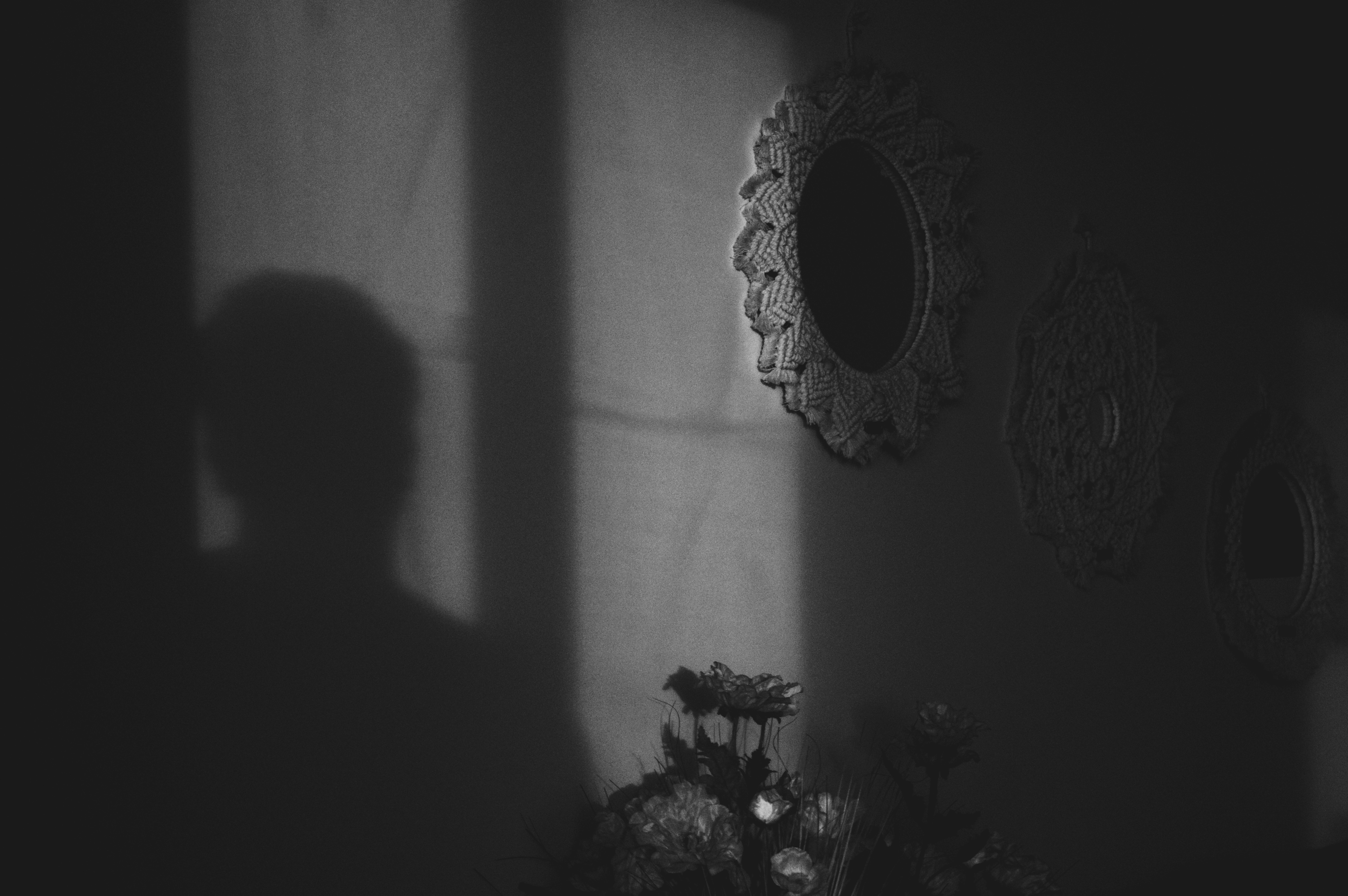 Shadowed Gallery: Quiet Portrait in a Dimly Lit Room