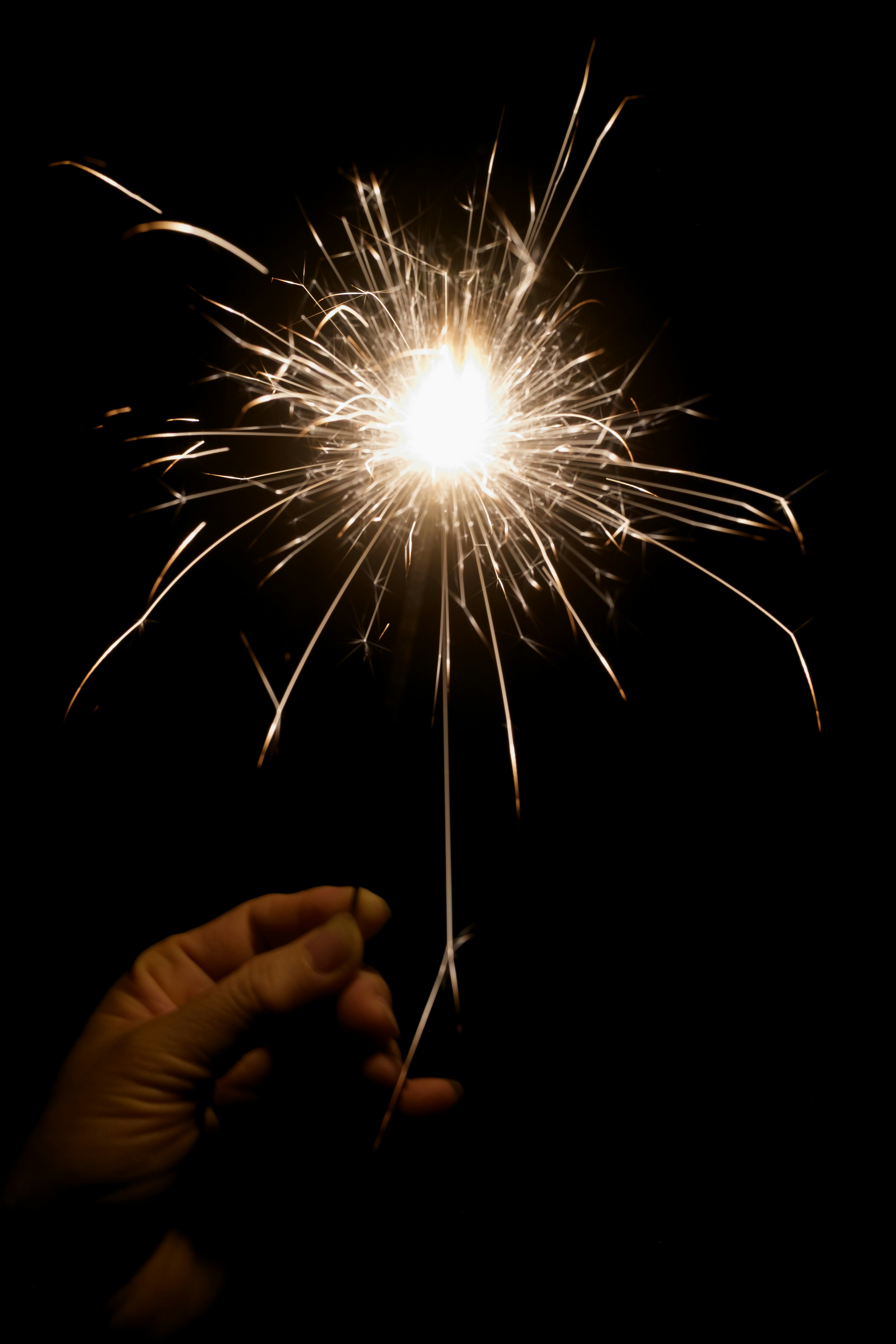 Spark of Celebration: Handheld Sparkler Against Night