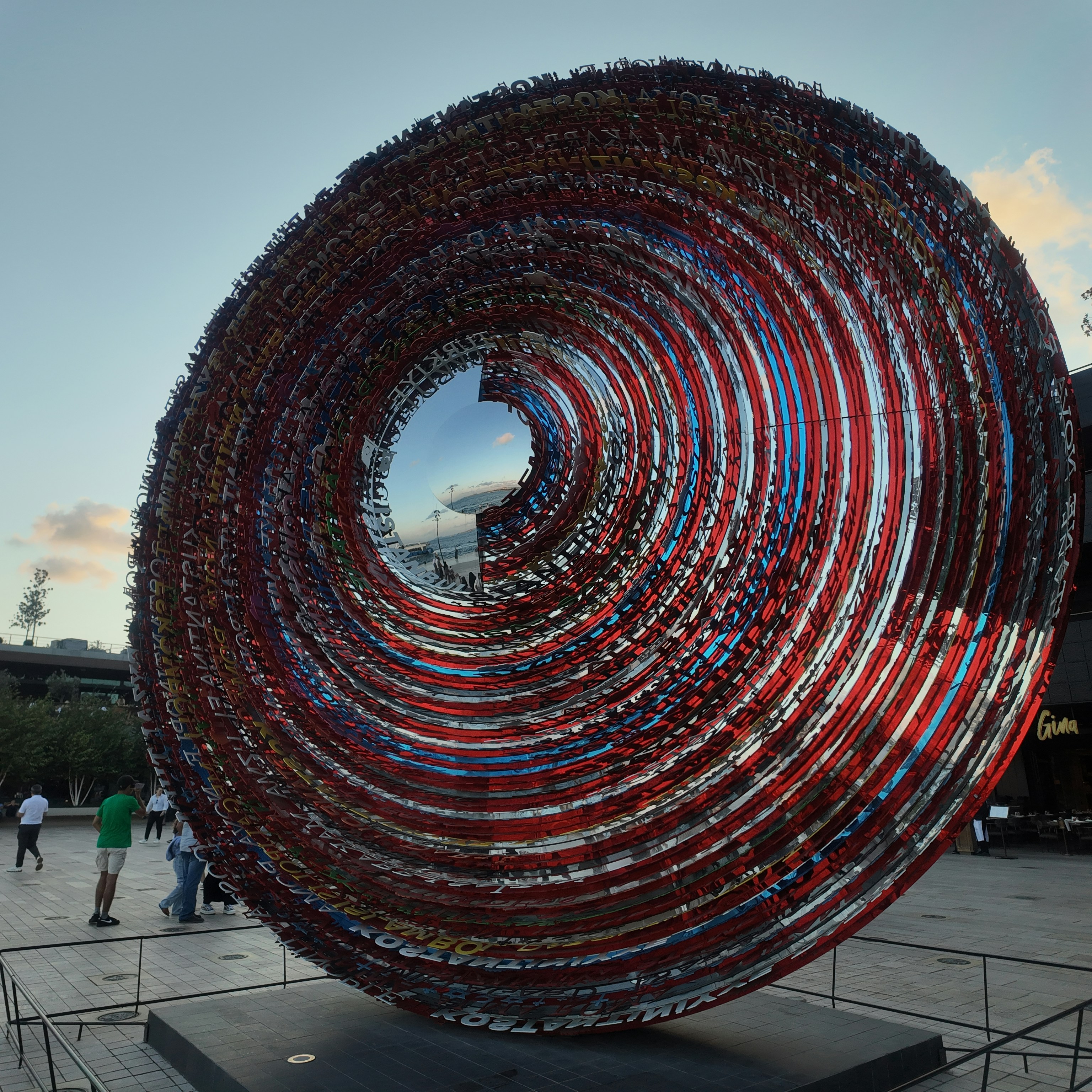 Circular Echo: A Massive Public Art Wheel Framed Against an Open Plaza