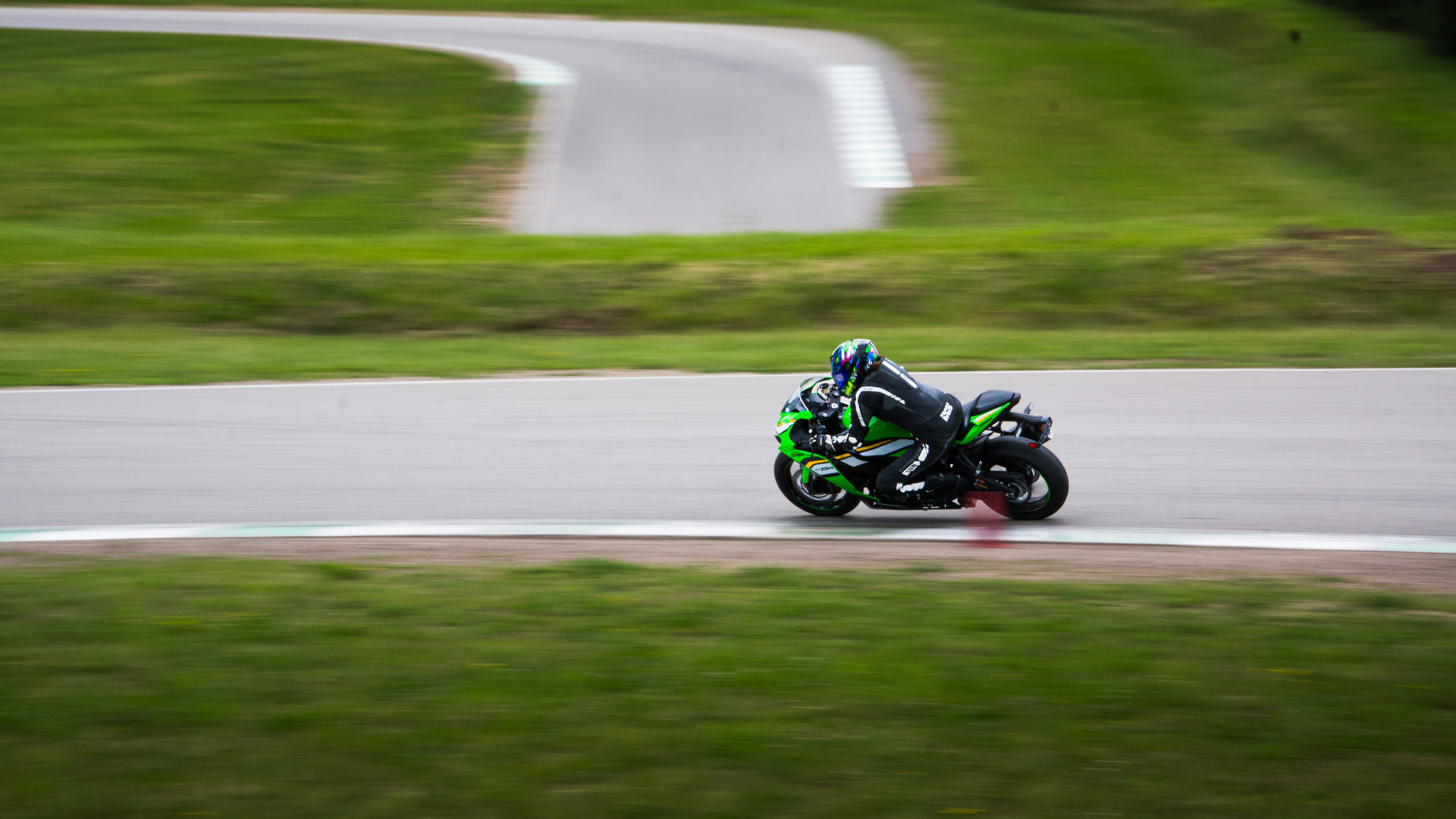 Green Lightning on Tarmac: A Lean Rider in Focus
