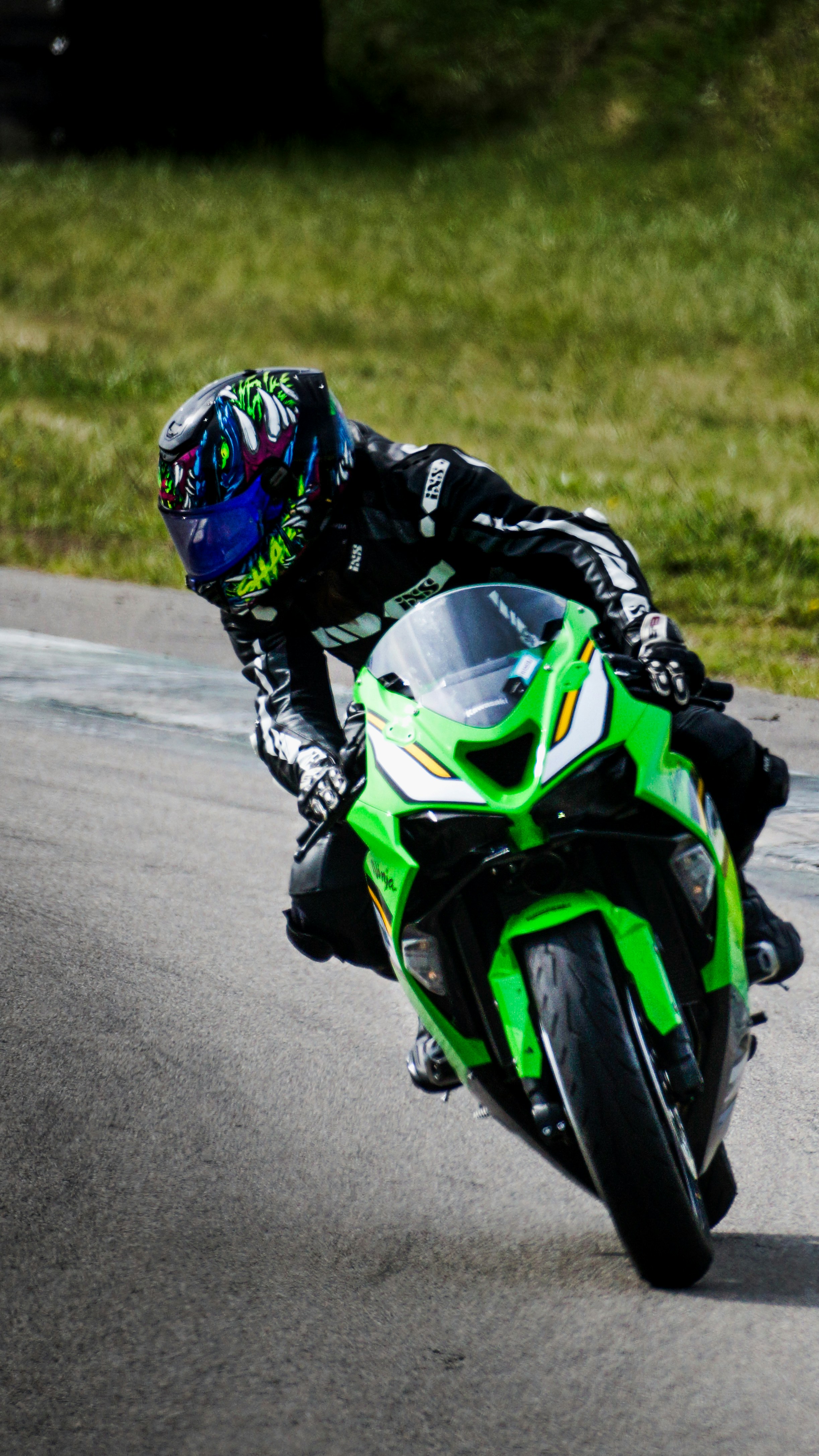 Green Lightning: A Rider Carves Through Turn on Neon Kawasaki