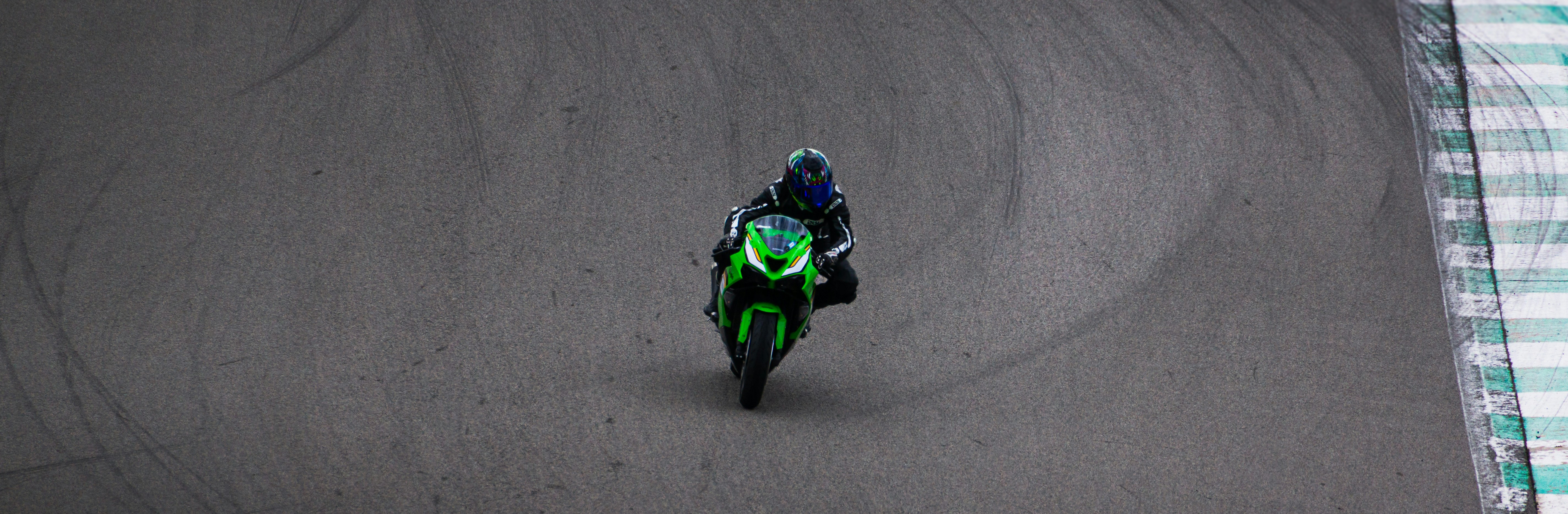 Neon Green Racer Surges Through a Curved Asphalt Bend