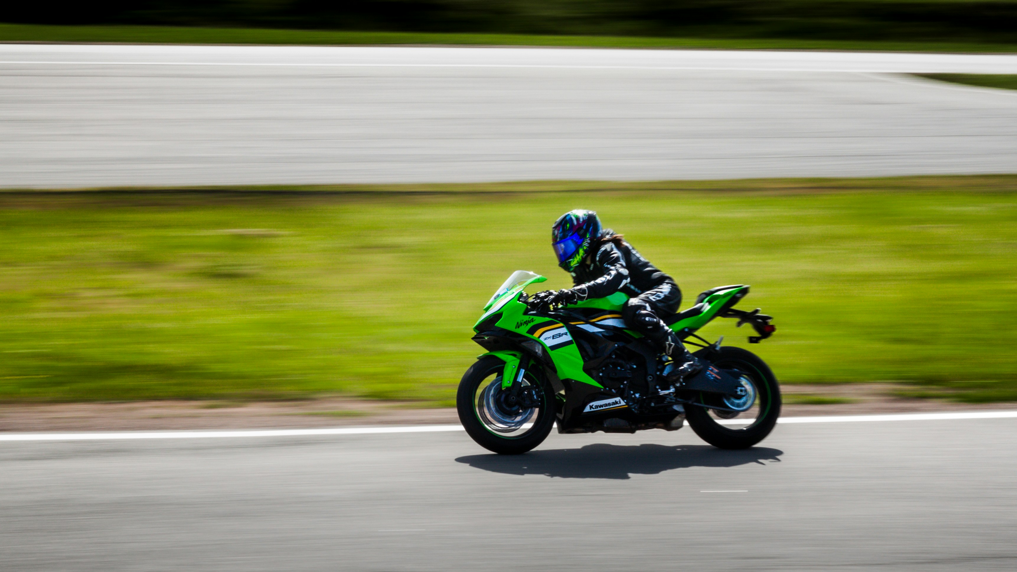 Green Blur: A Rider in Focus on the Speed Line