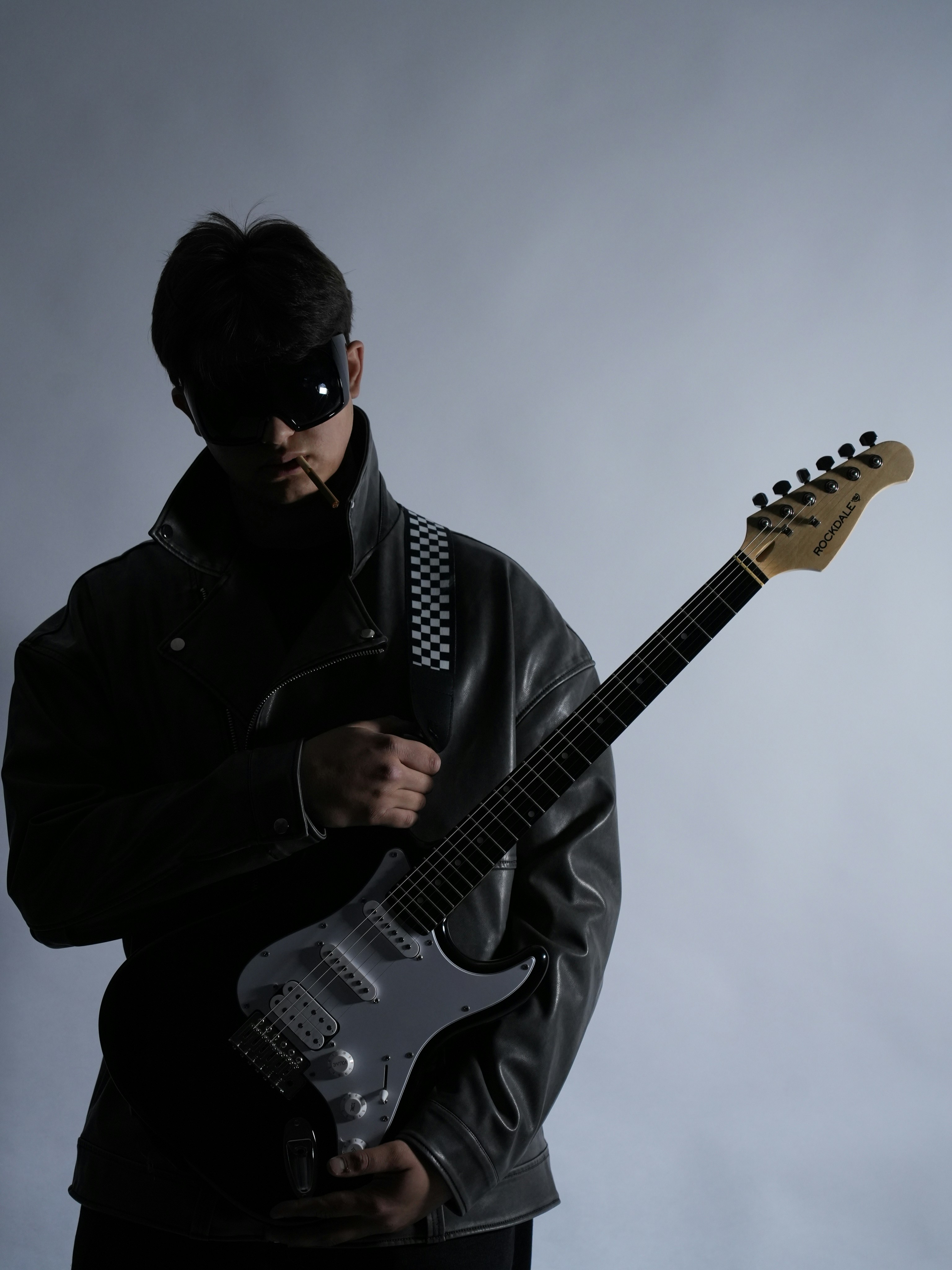Shadowed Strings: A Night-in-Black Leather Guitarist