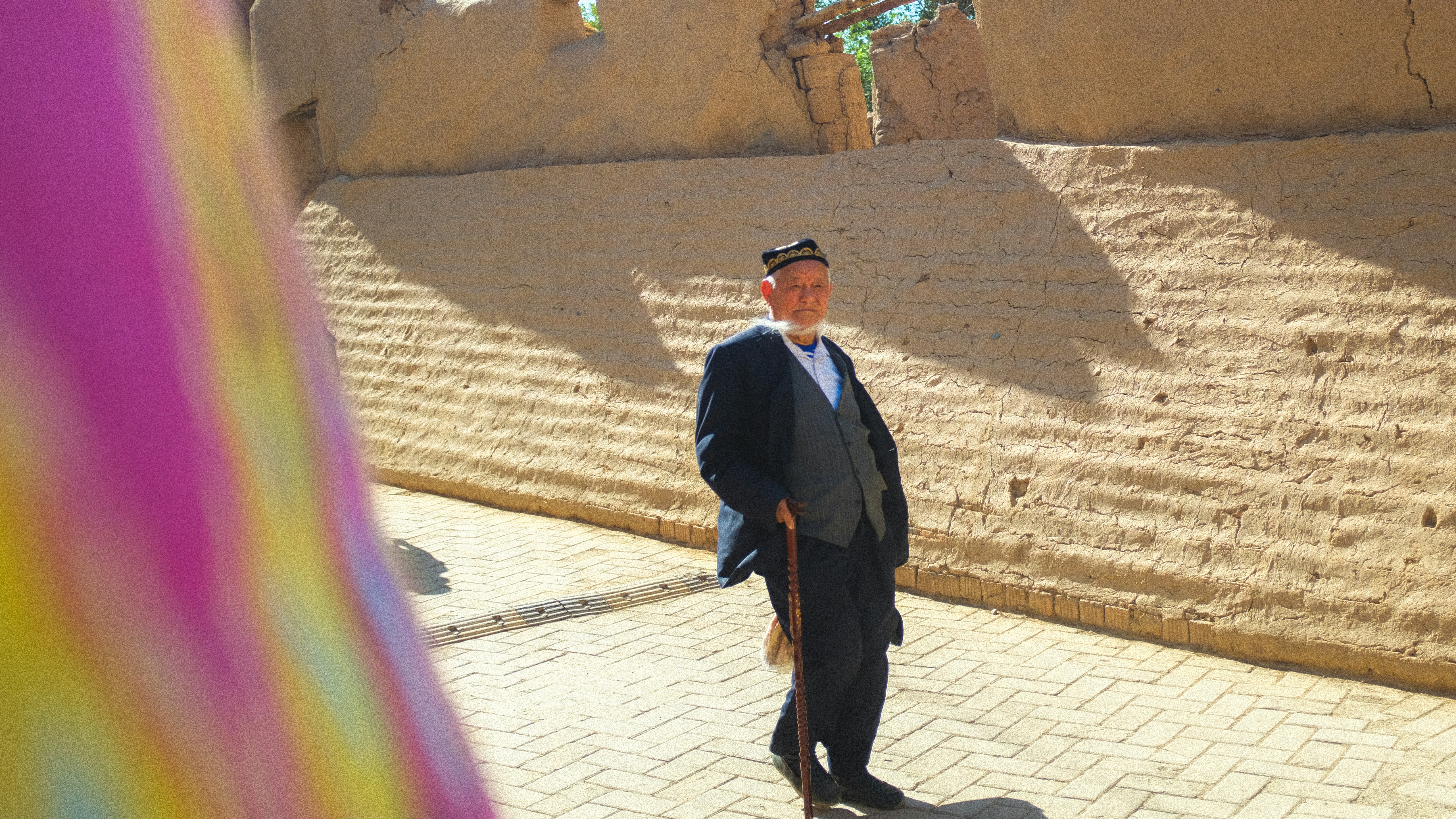 A Quiet Evening in the Alley: A Dapper Figure Against Sunlit Brick
