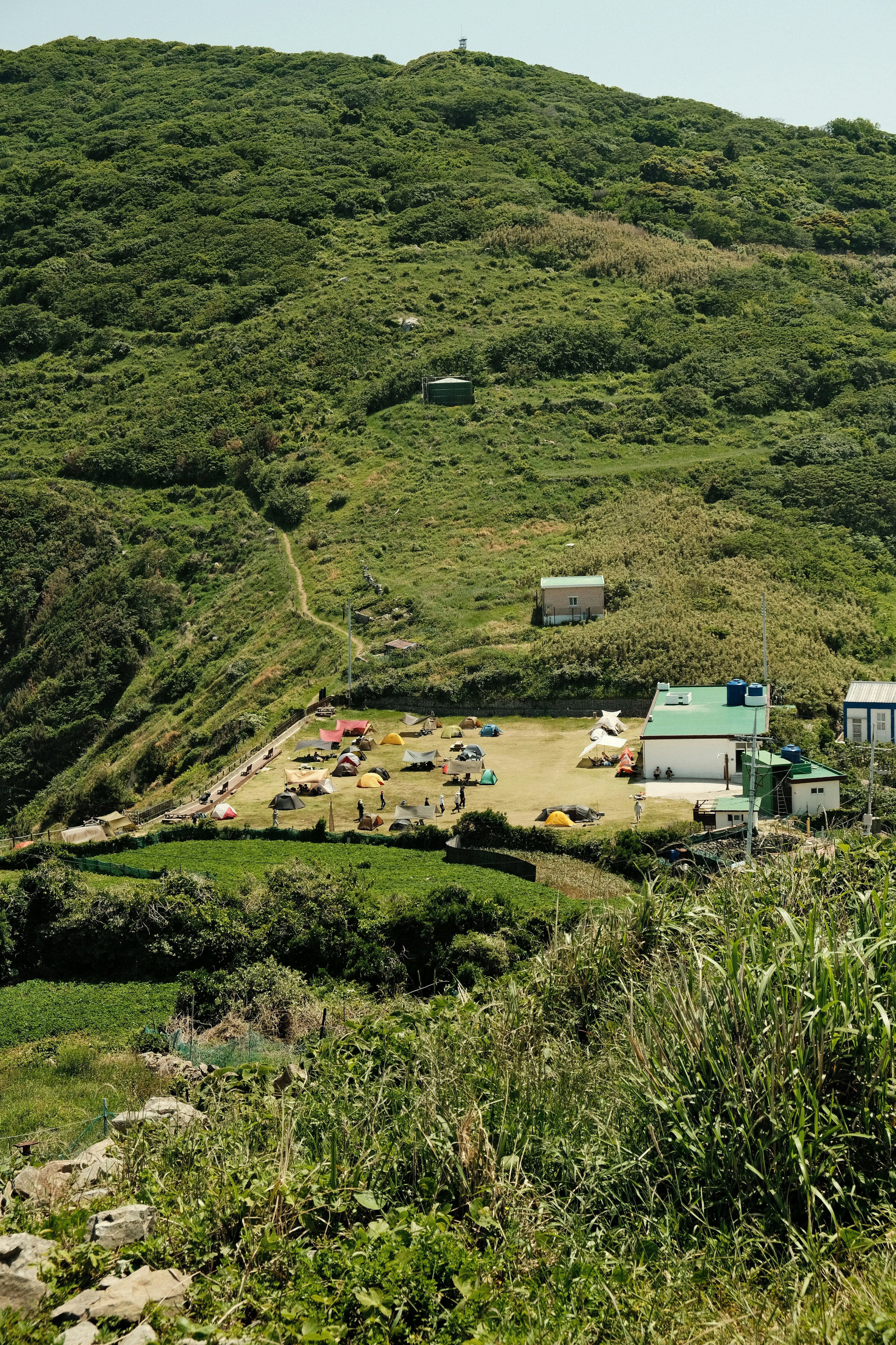 Clifftop Camp Under a Green Saddle: Tented Village on a Hill