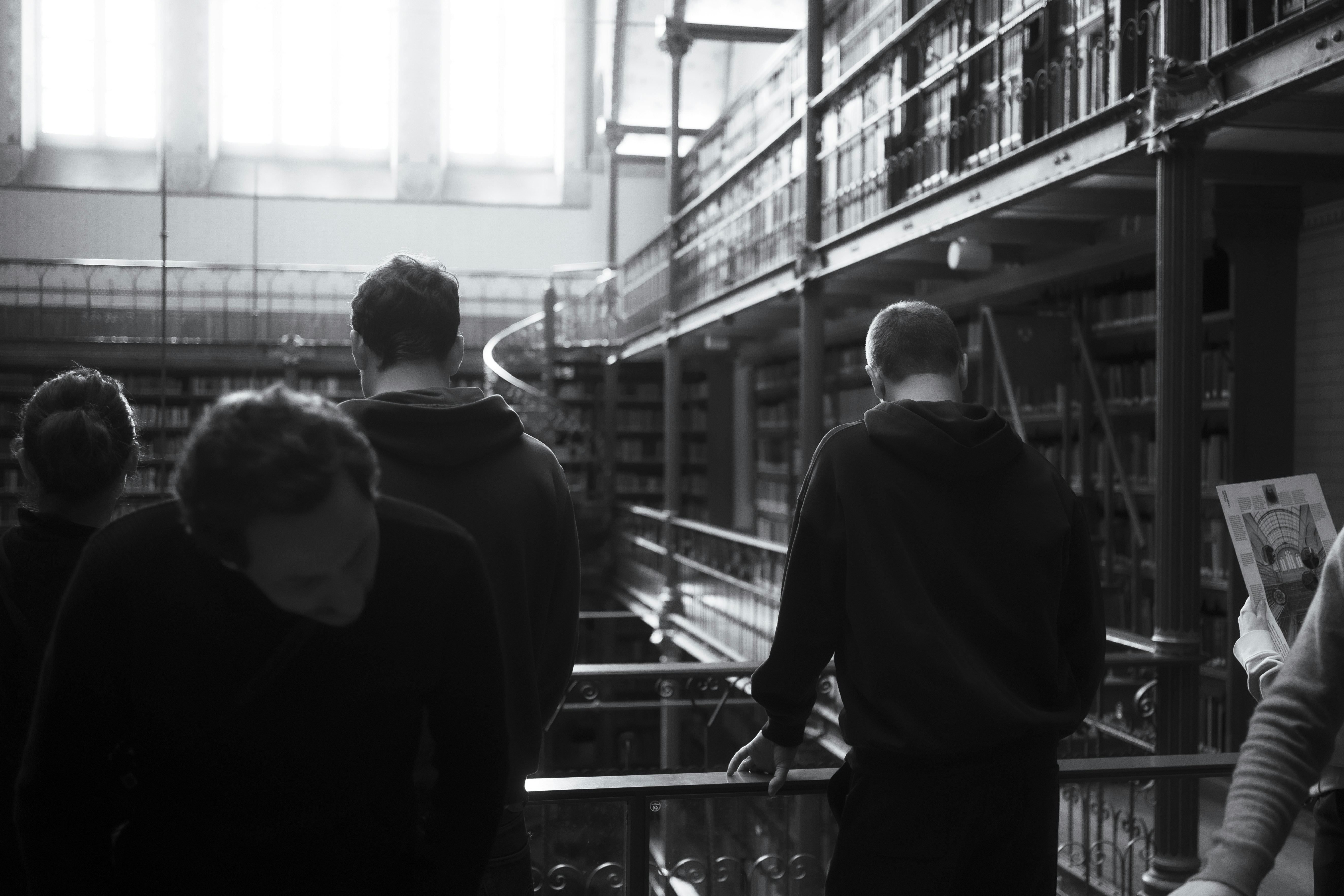 Silhouetted Figures in a Quiet Library At Dusk