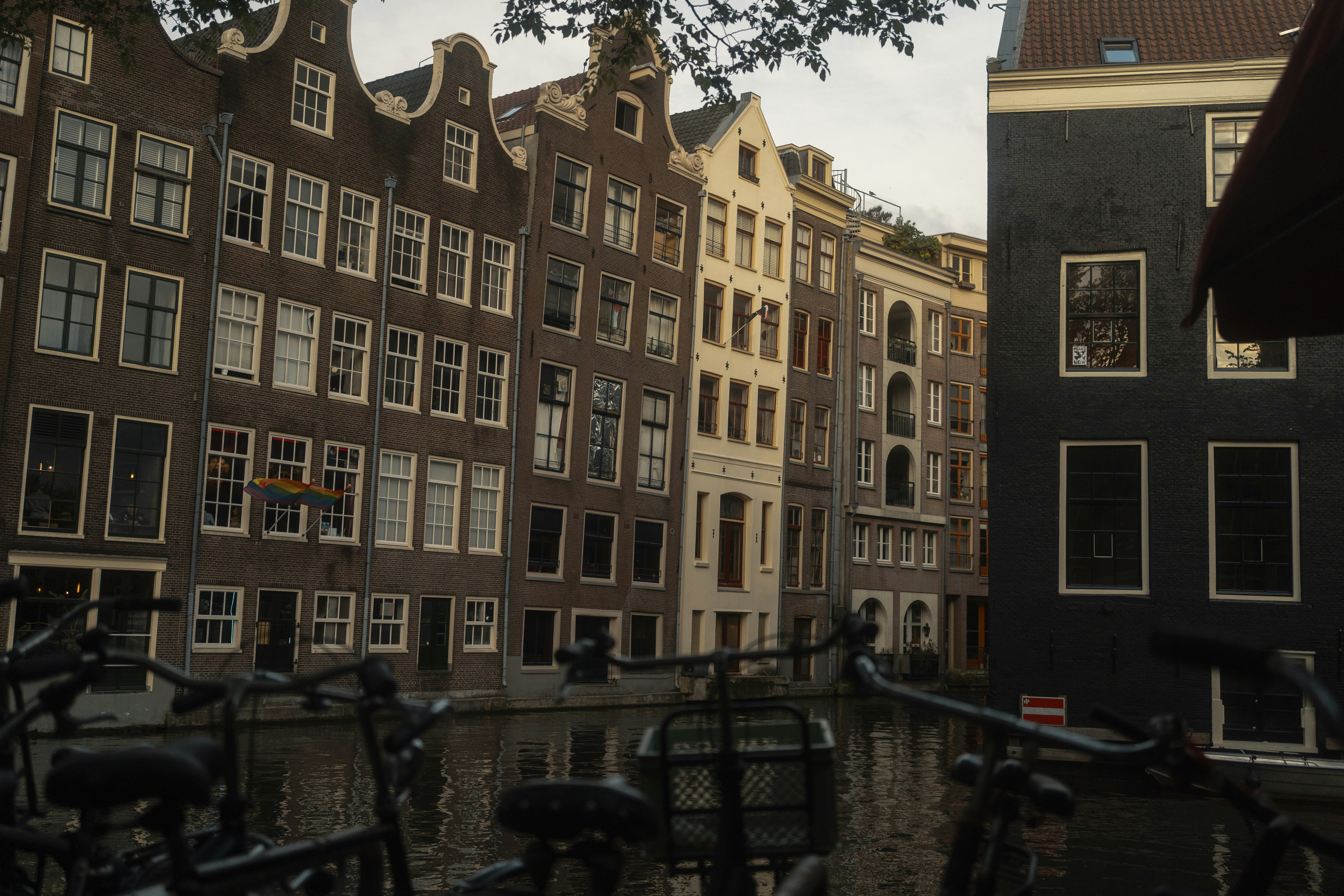 Canal in Amsterdam: Silent Row of Gabled Houses by a Narrow Waterway