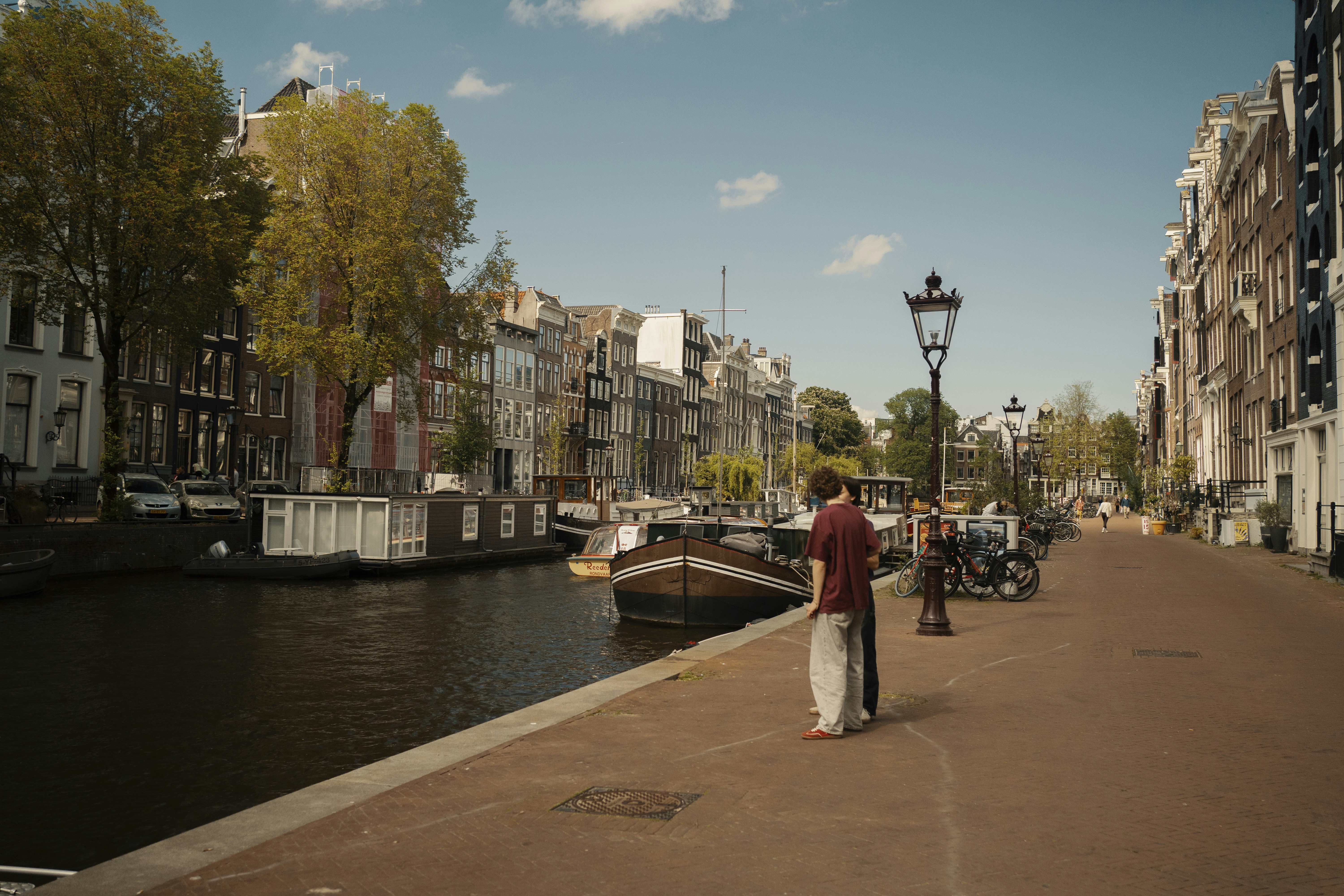 Walking Along the Sunlit Amsterdam Canal
