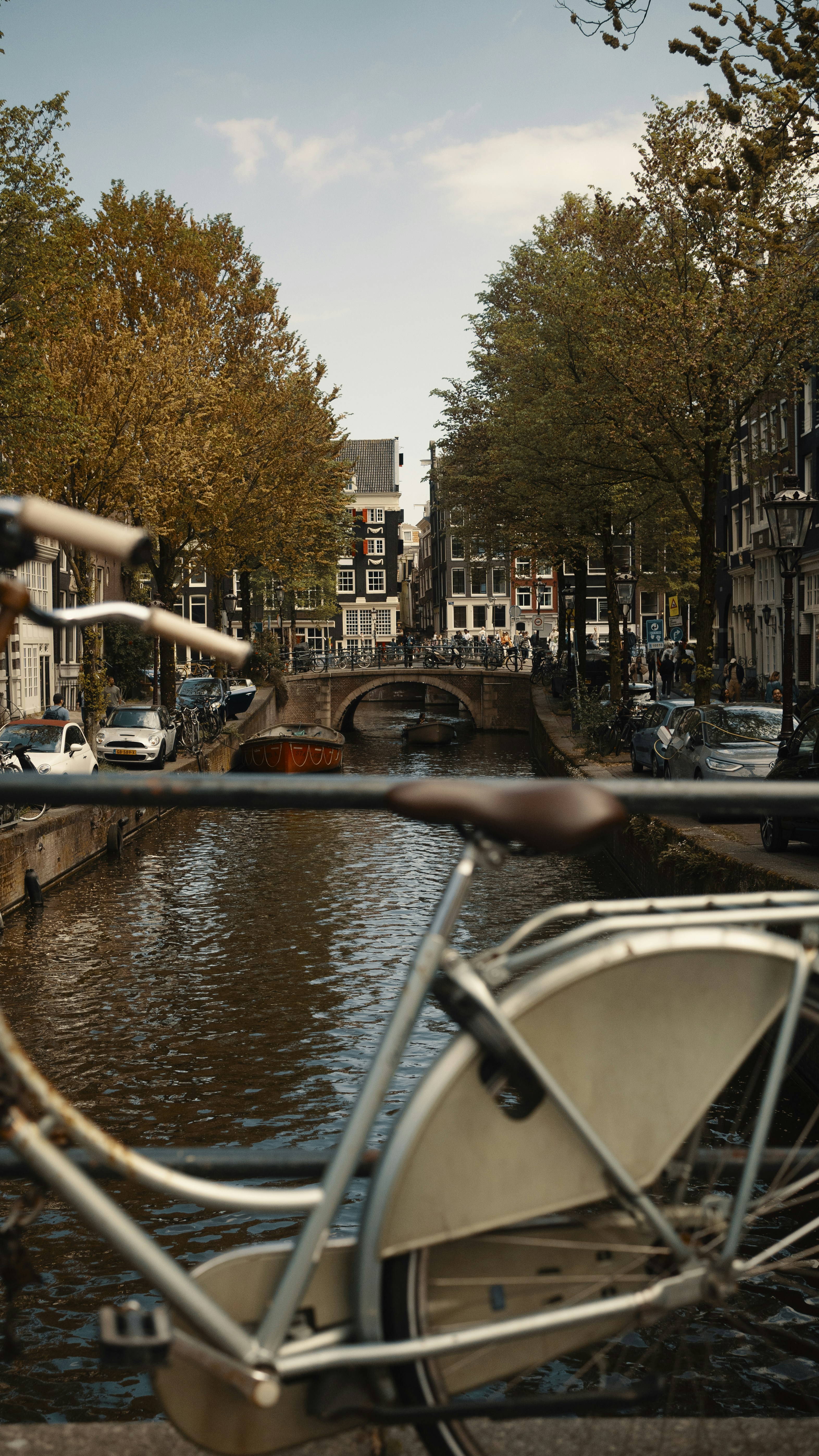 Bike in the Foreground, Canal and Bridge in Autumn Streets