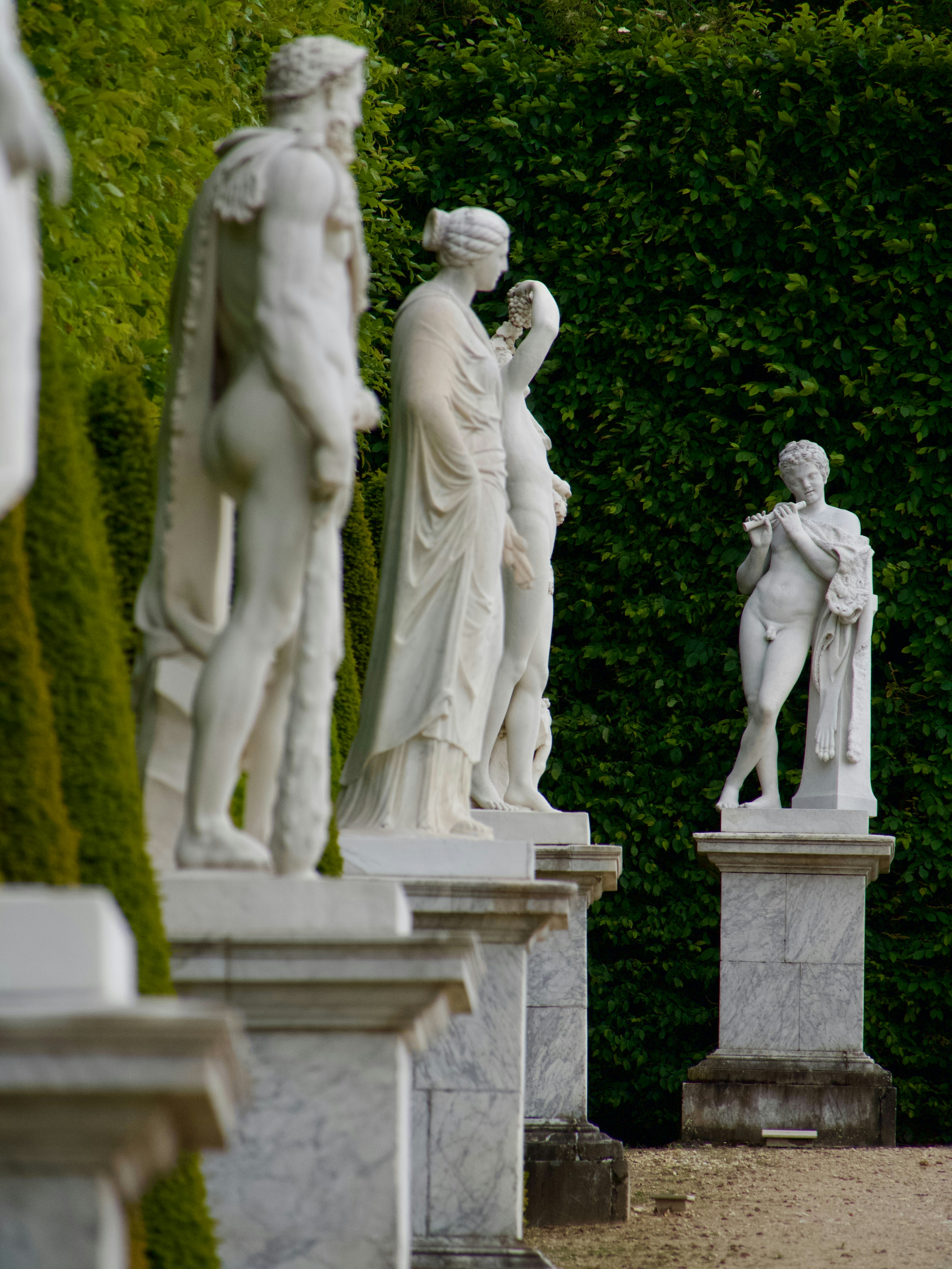 Statues in a Garden Corridor
