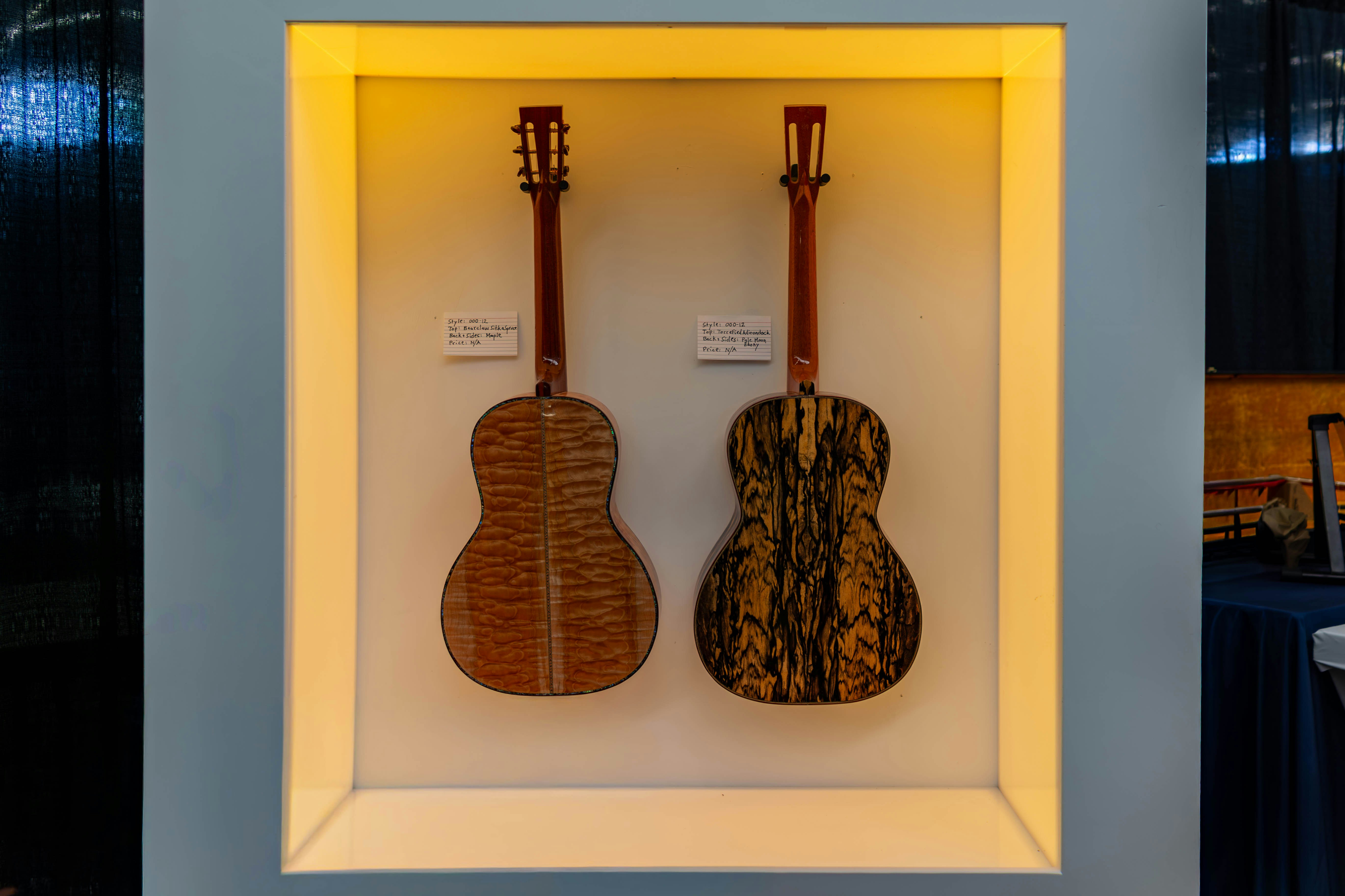 Guitars in a glow: twin carved instruments on display