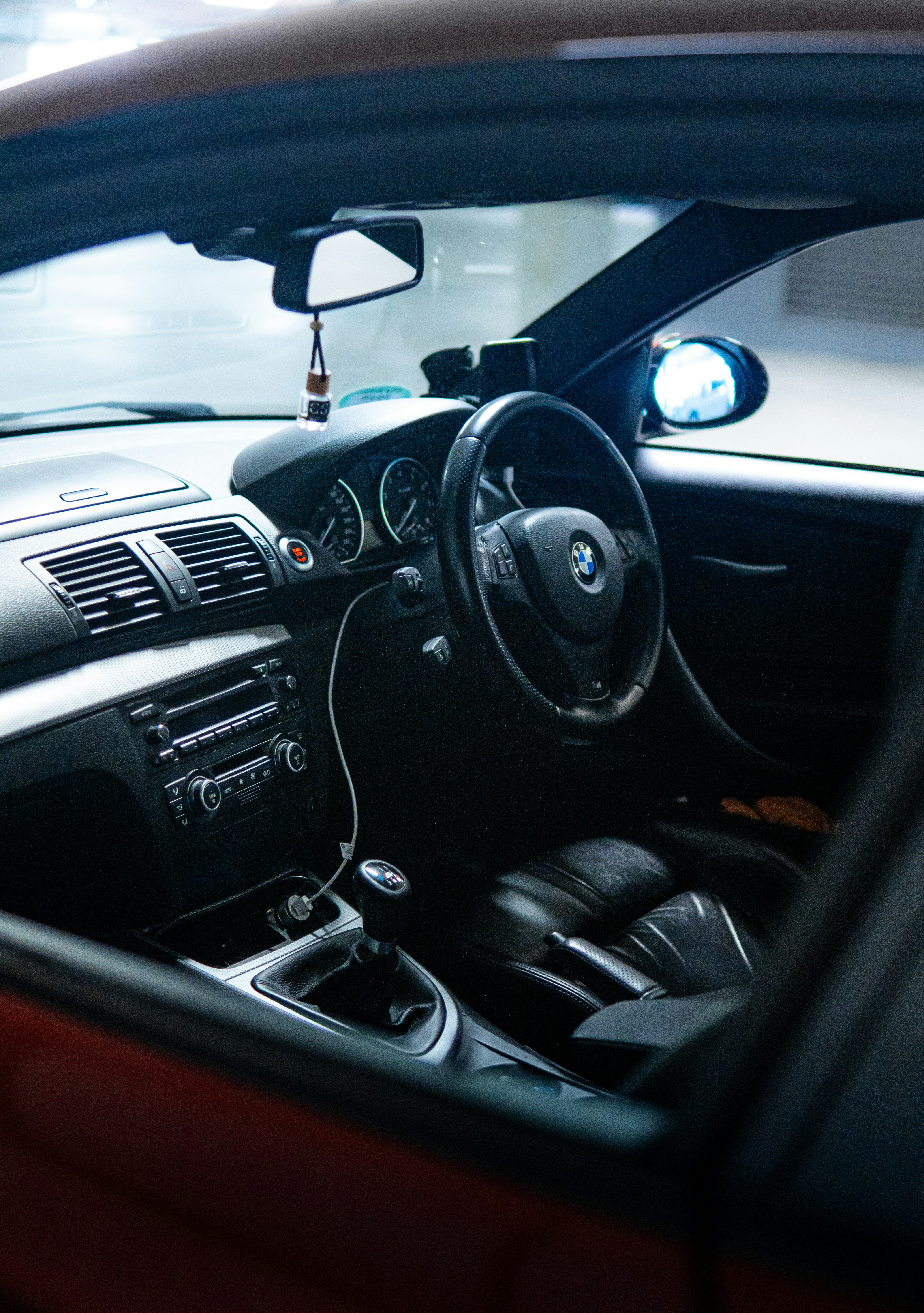 BMW cockpit: steering wheel centered in a moody car interiors shot