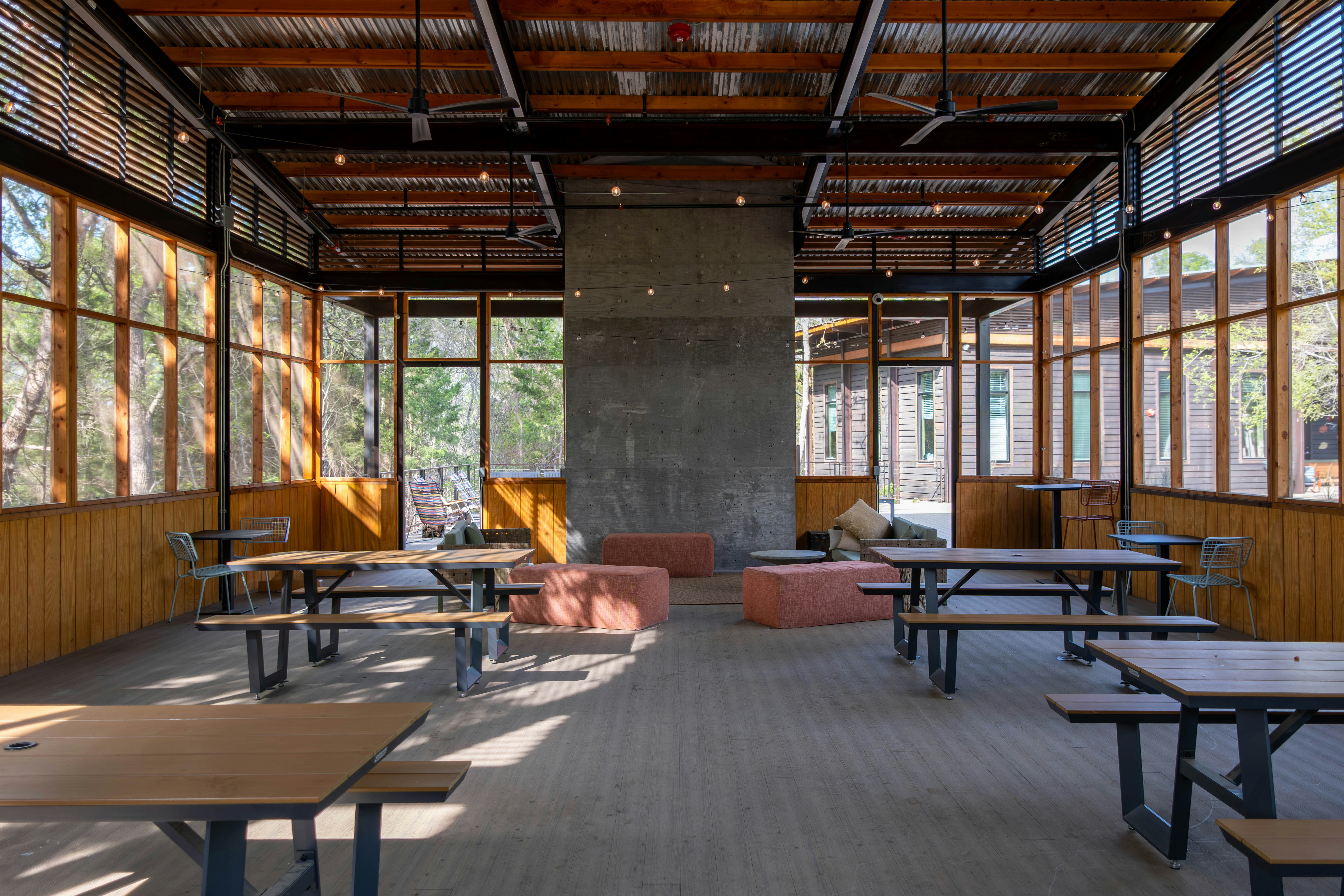 Sunlit Pavilion: Empty Picnic Tables Under a Modern Courtyard Roof