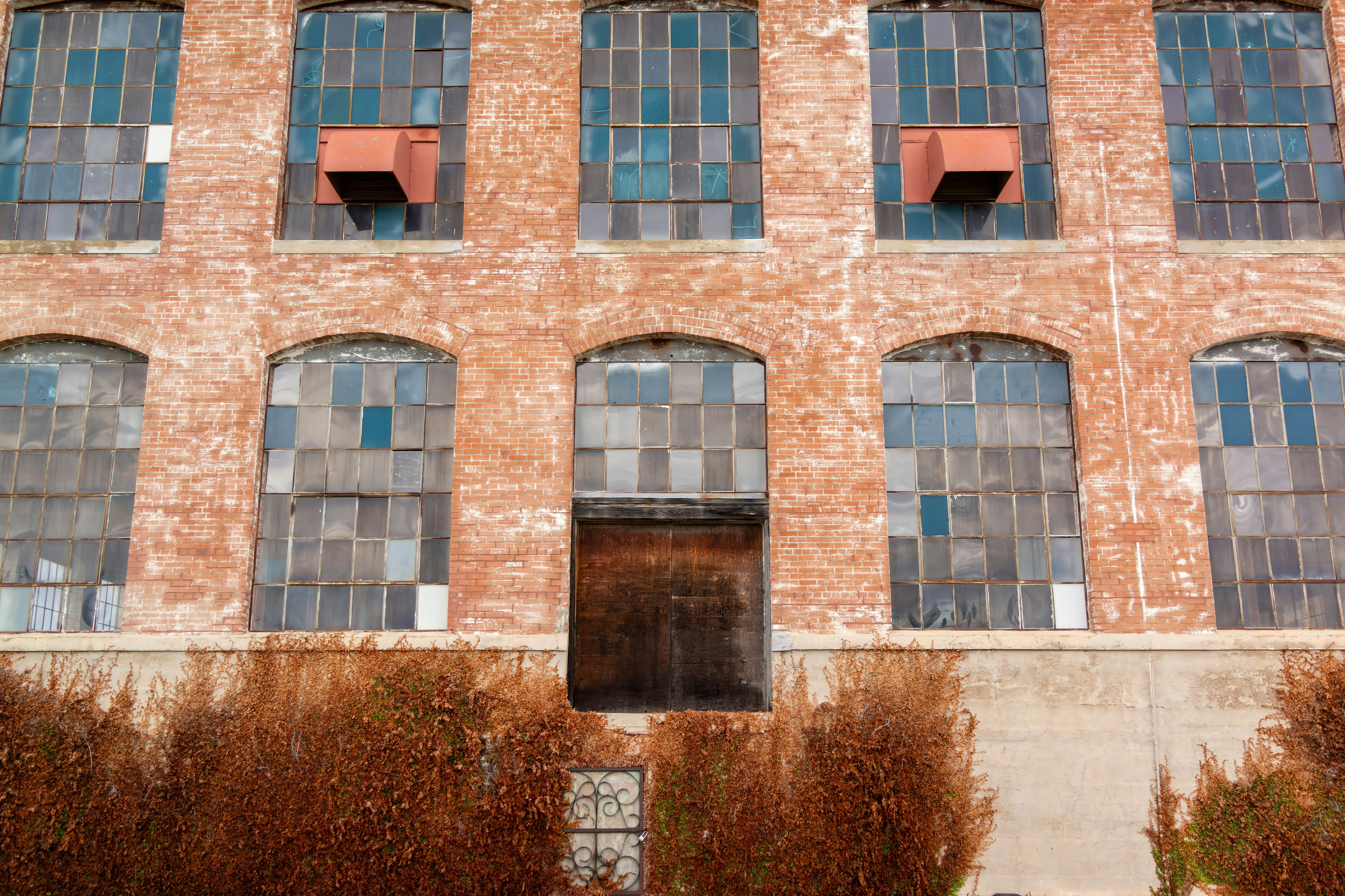 Abandoned Brick Factory: Sunlight on Rusted Doorways