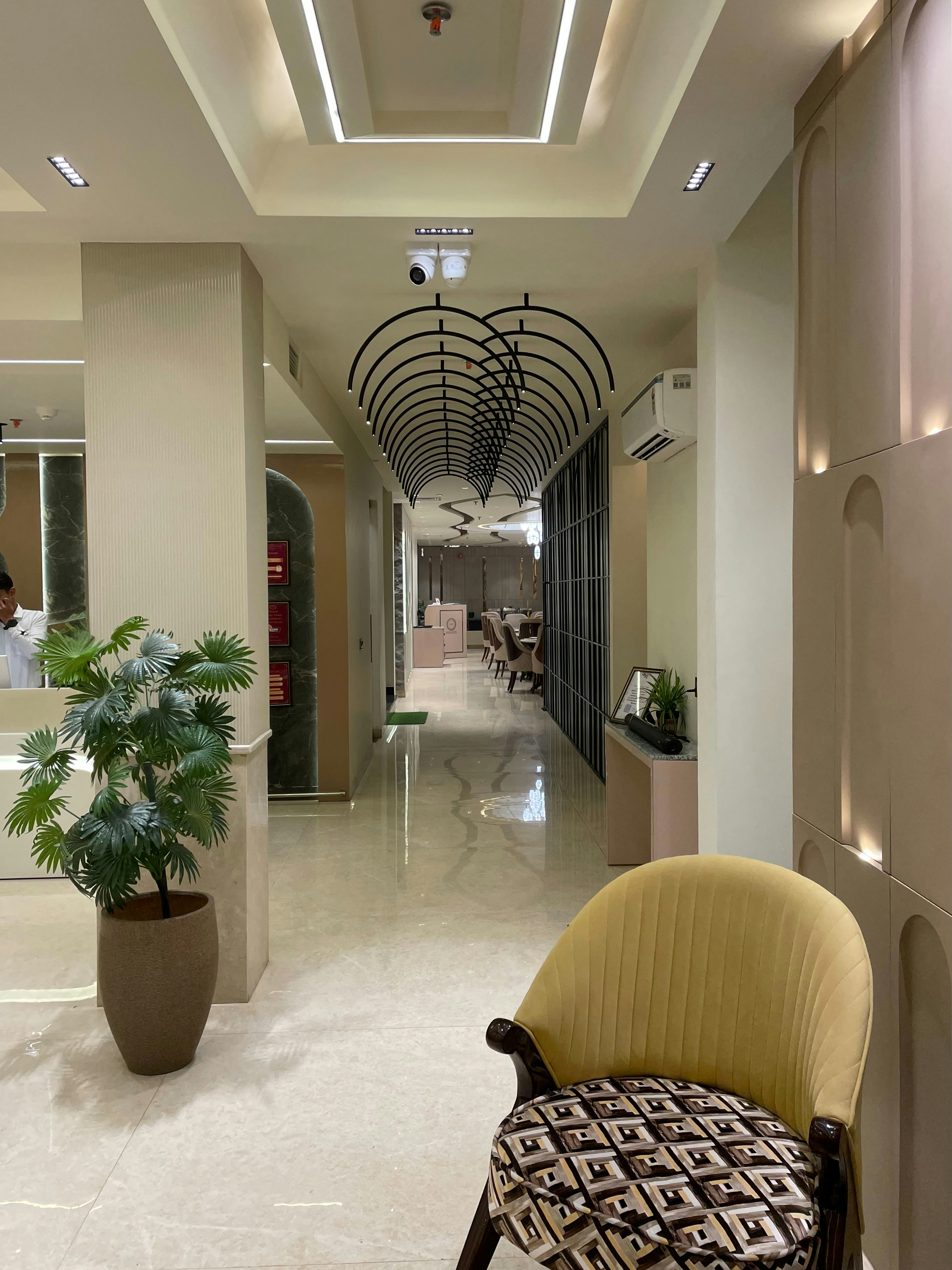 Hotel Lobby Corridor with Arching Ceiling Motif and Plush Seating