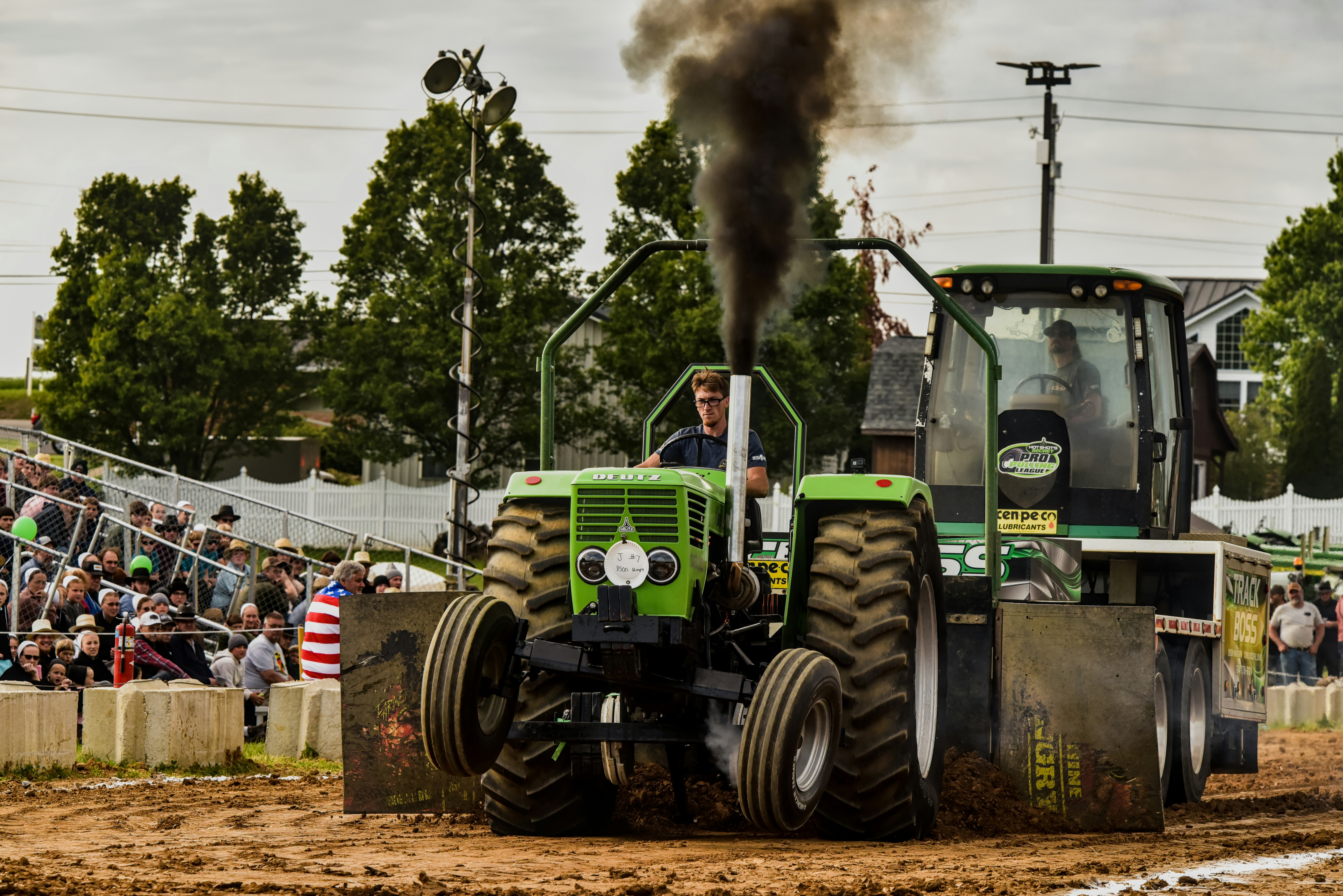 Power and grit: a tractor burnout under smoky skies
