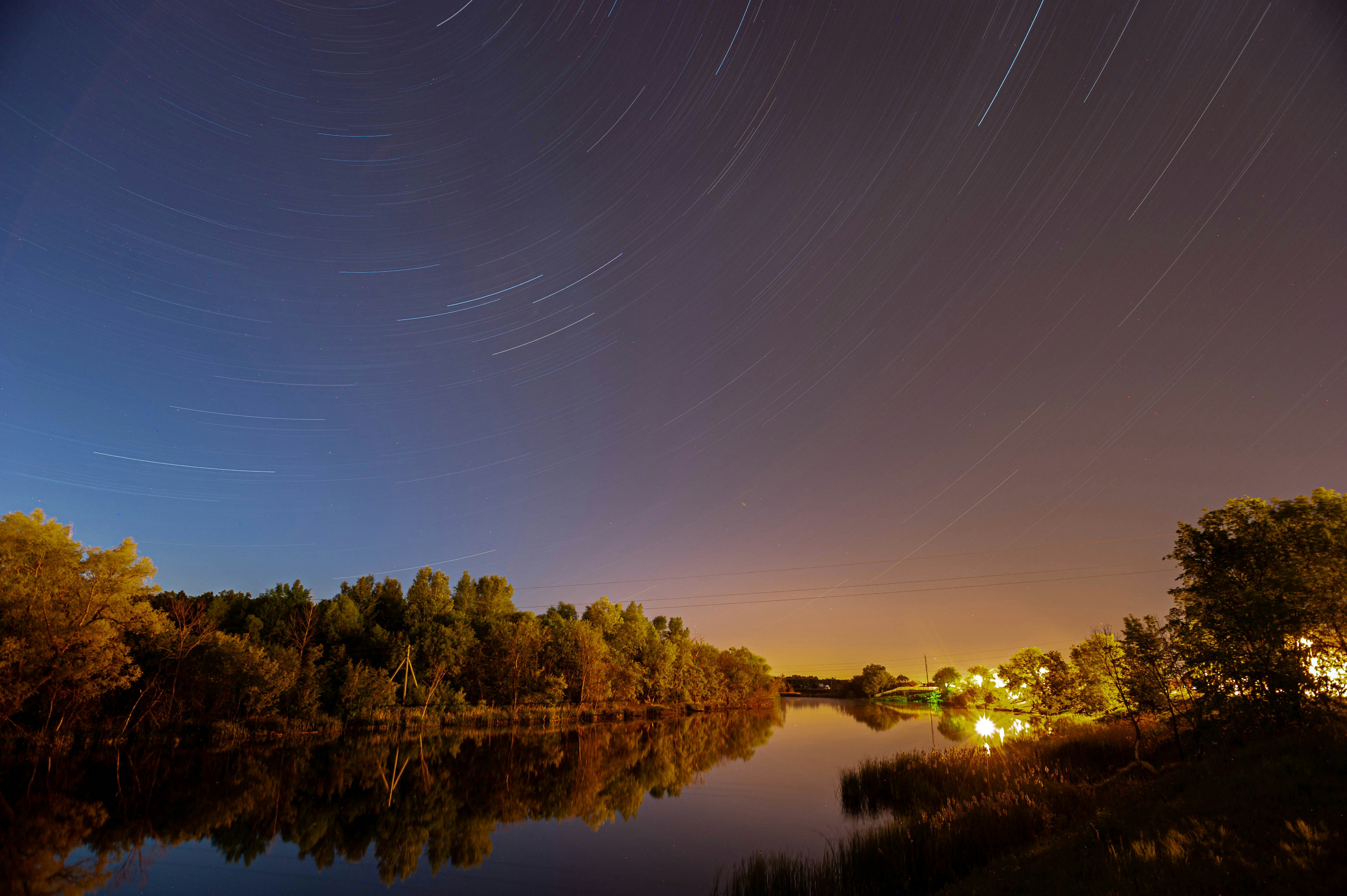 Riverbank Nightscape Under Circular Star Trails