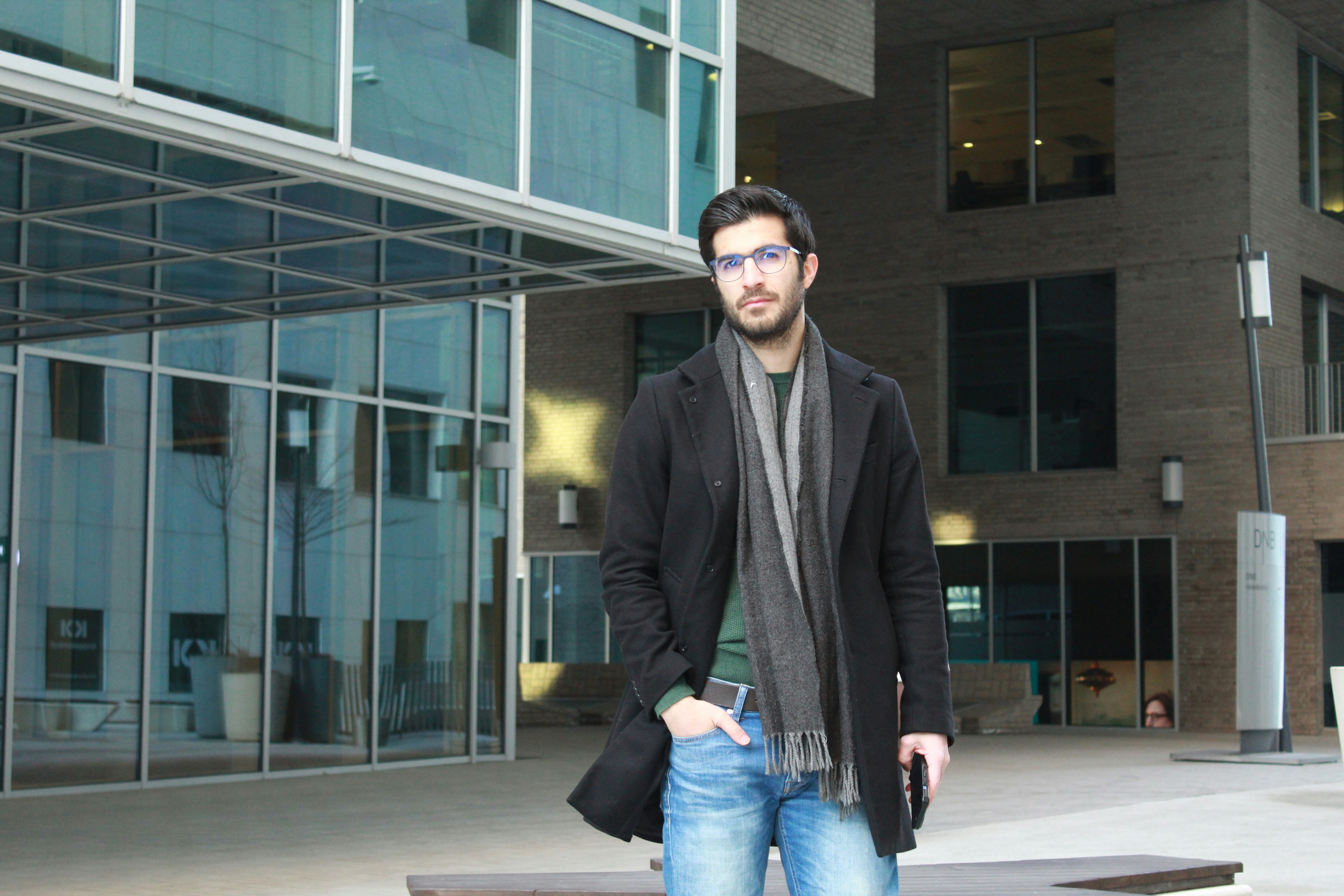 Self-assured silhouette in a glass-and-concrete campus plaza