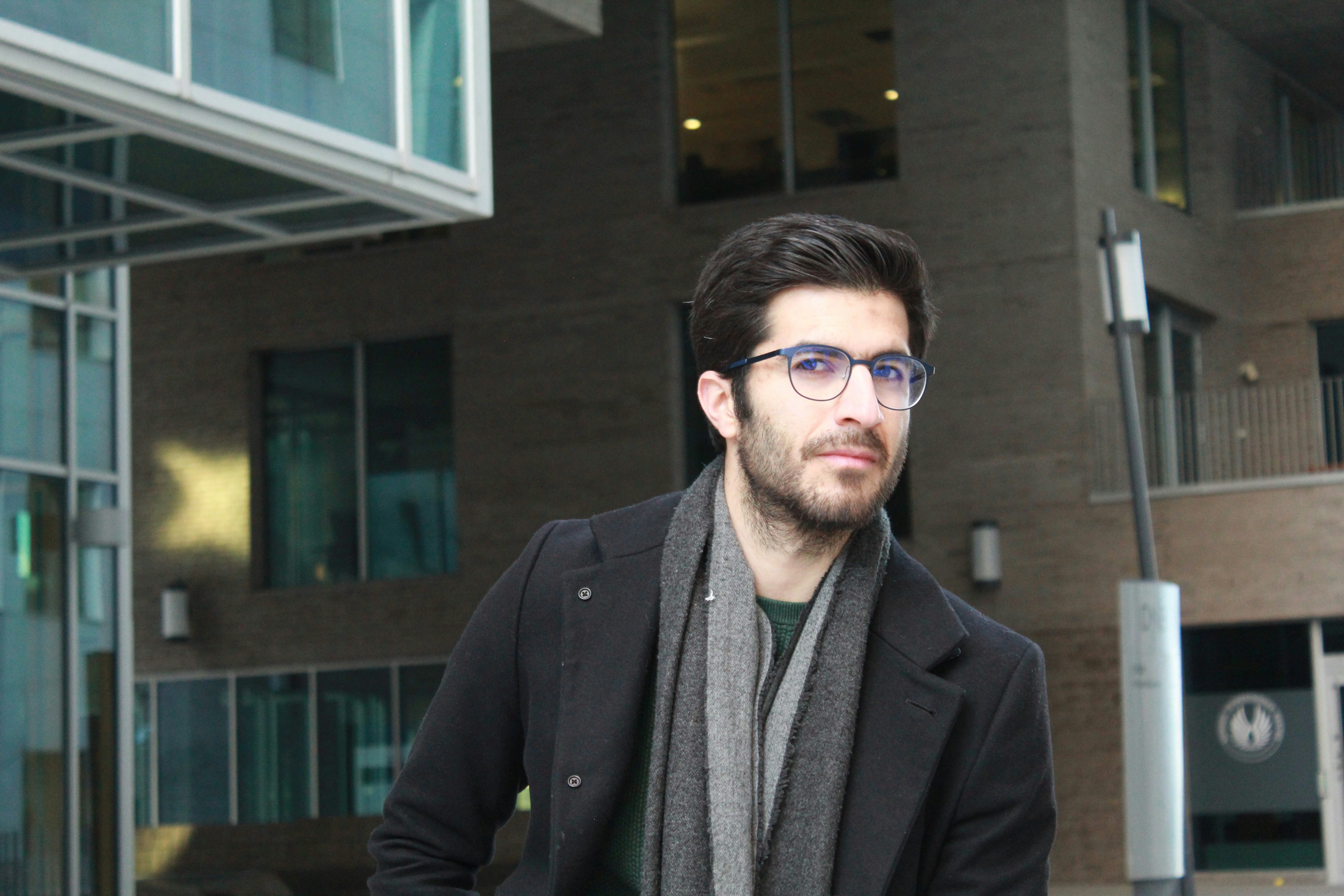 Urban Portrait: A Thoughtful Gaze by the Modern Facade