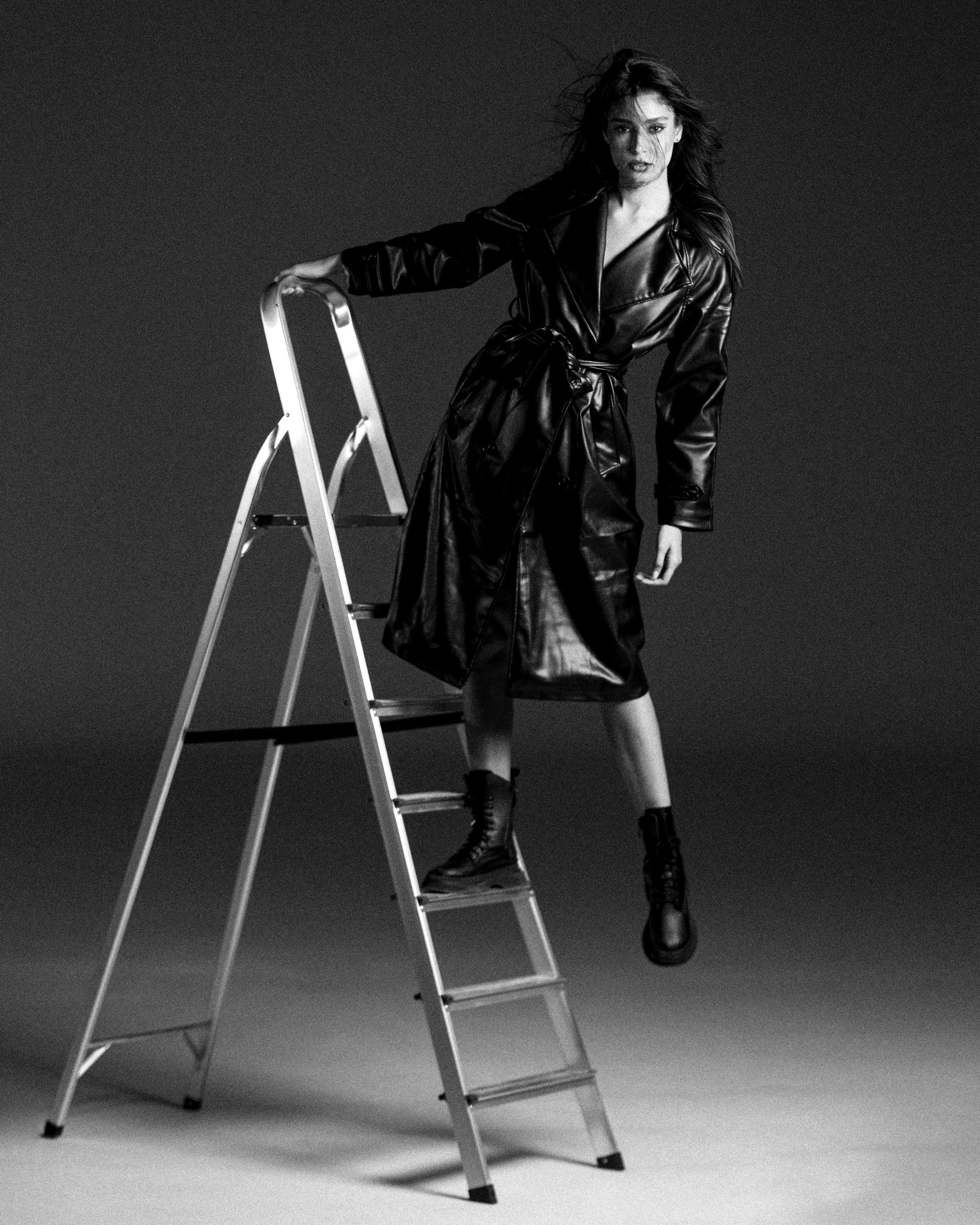 Ascending Noir: A Leathered Presence on the Ladder