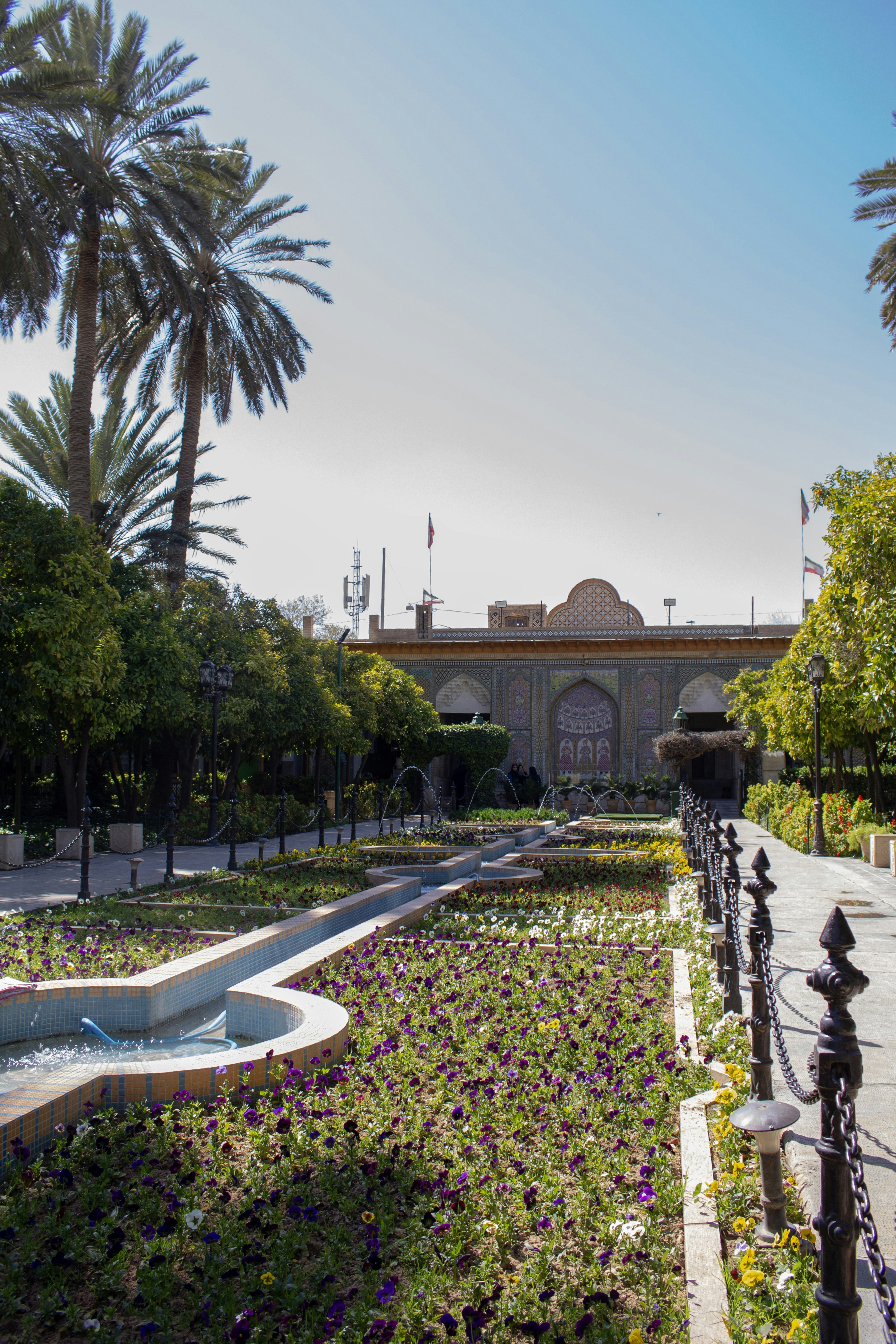 Sunlit Formal Garden Leading to Historic Facade