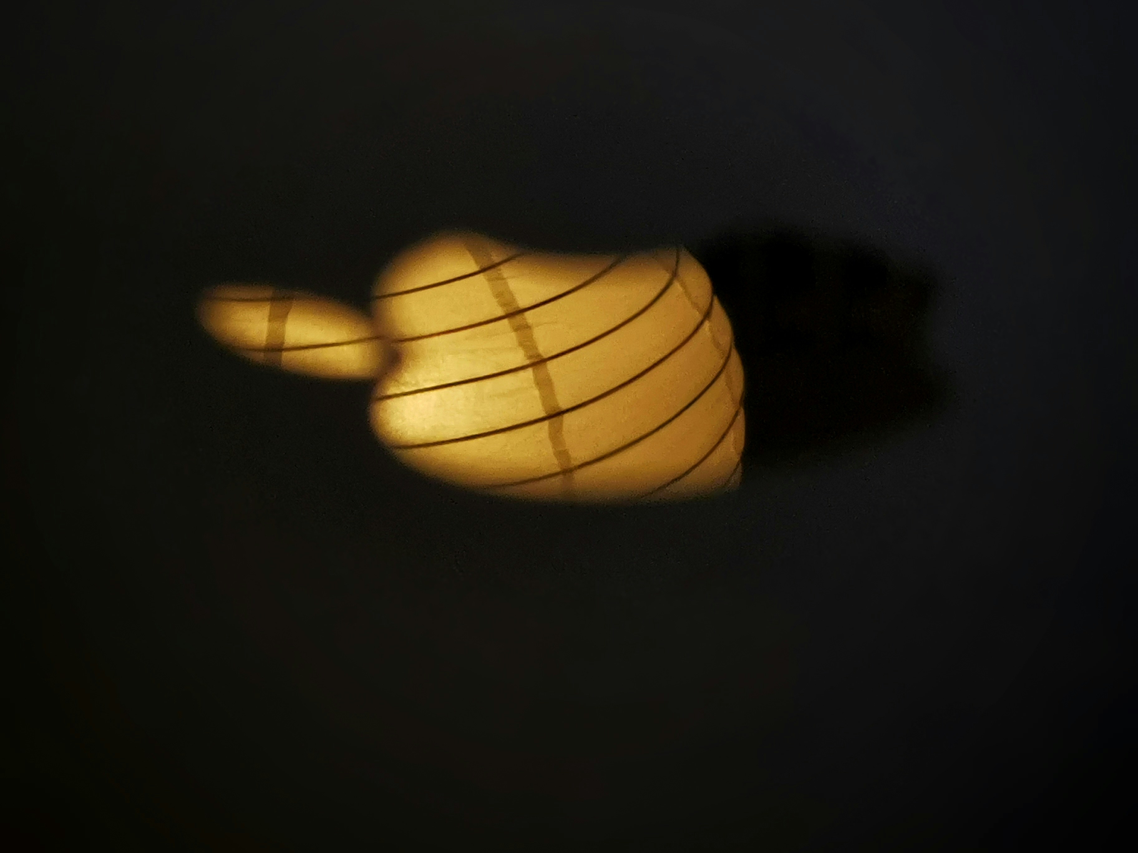Orbiting Lantern: a warm glow within a dark void