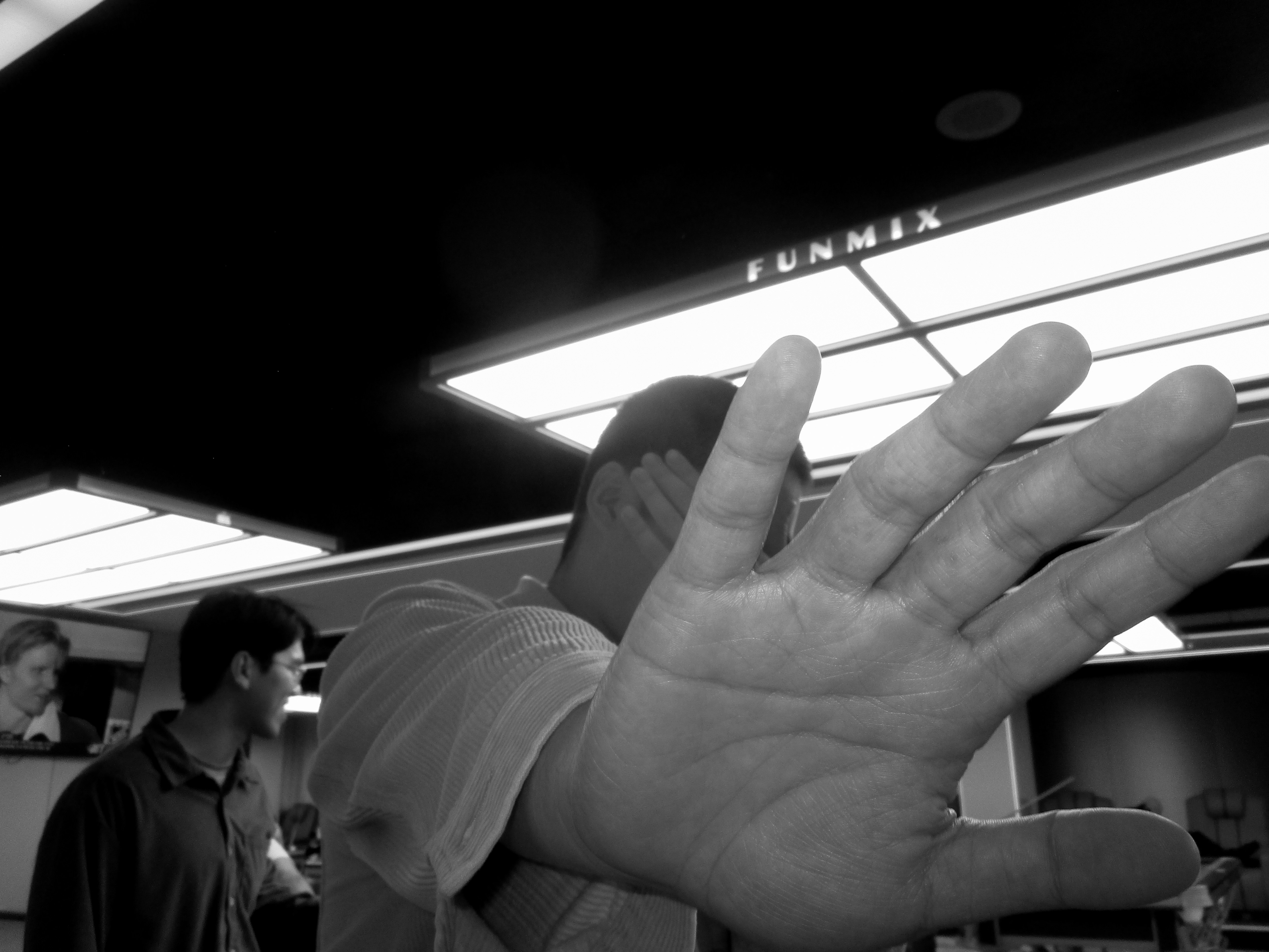 Raised Hand in a Busy Expo Hall