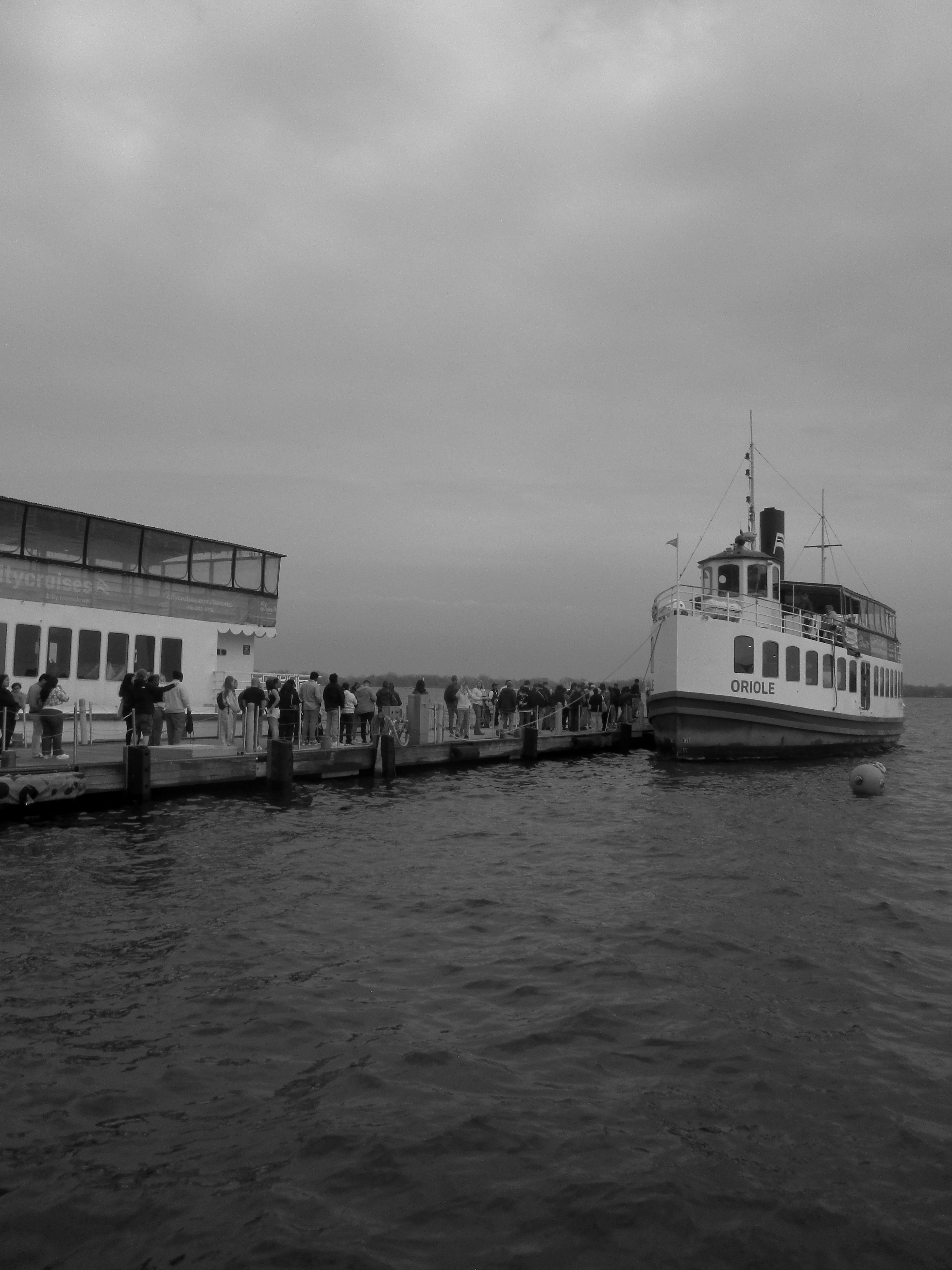 Dockside Steamship at Pier: Crowd and Vessel Align in Quiet Harbor