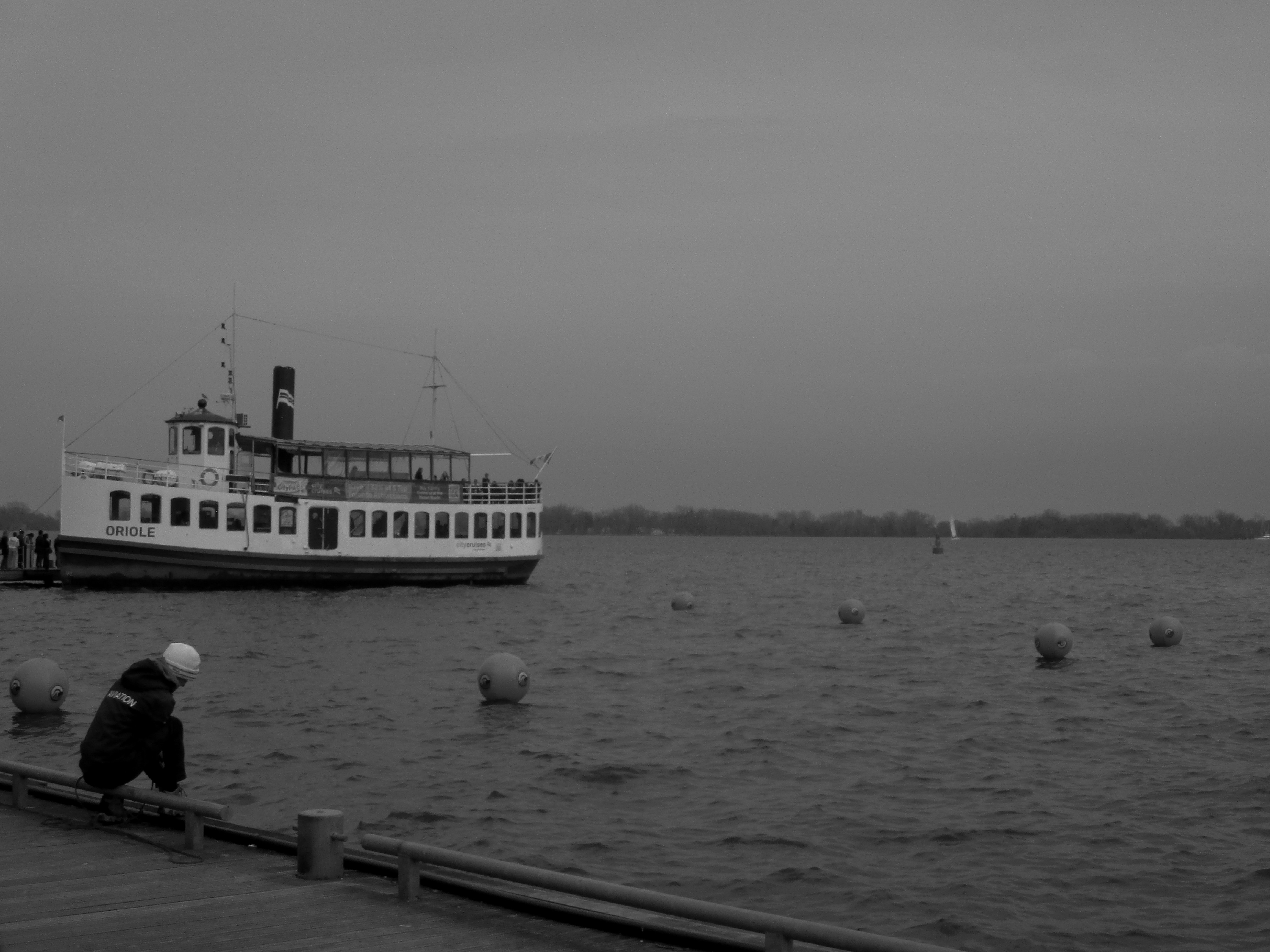 Harbor Vessel and Quiet Docks in Monochrome
